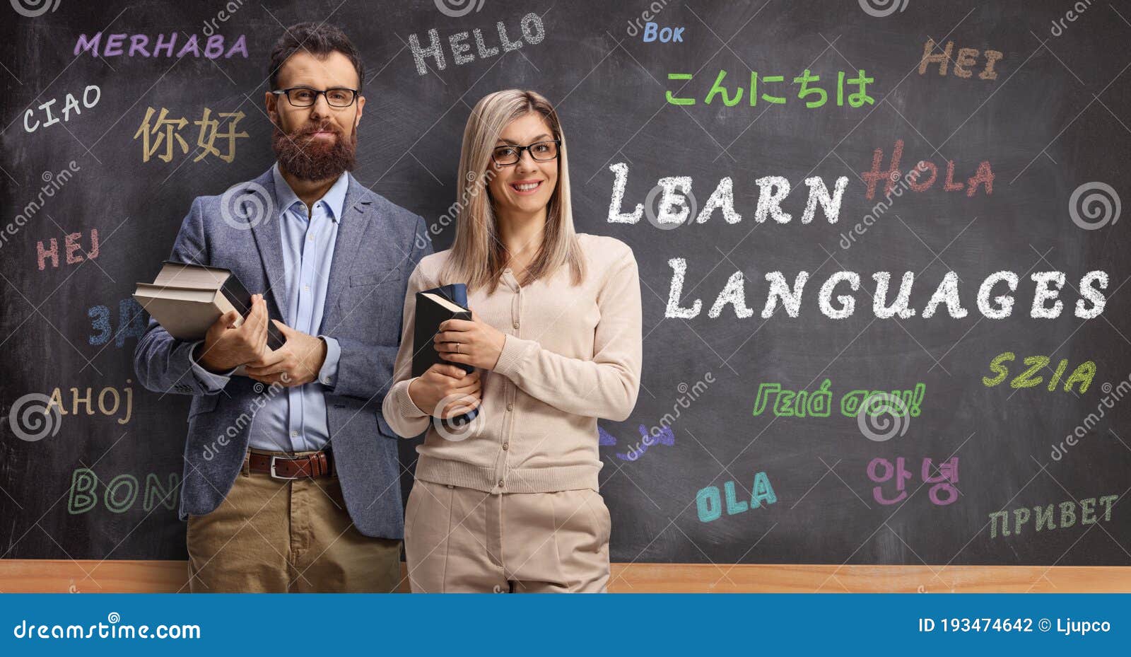 Male and Female Language Teachers in Front of a Blackboard Stock Photo ...