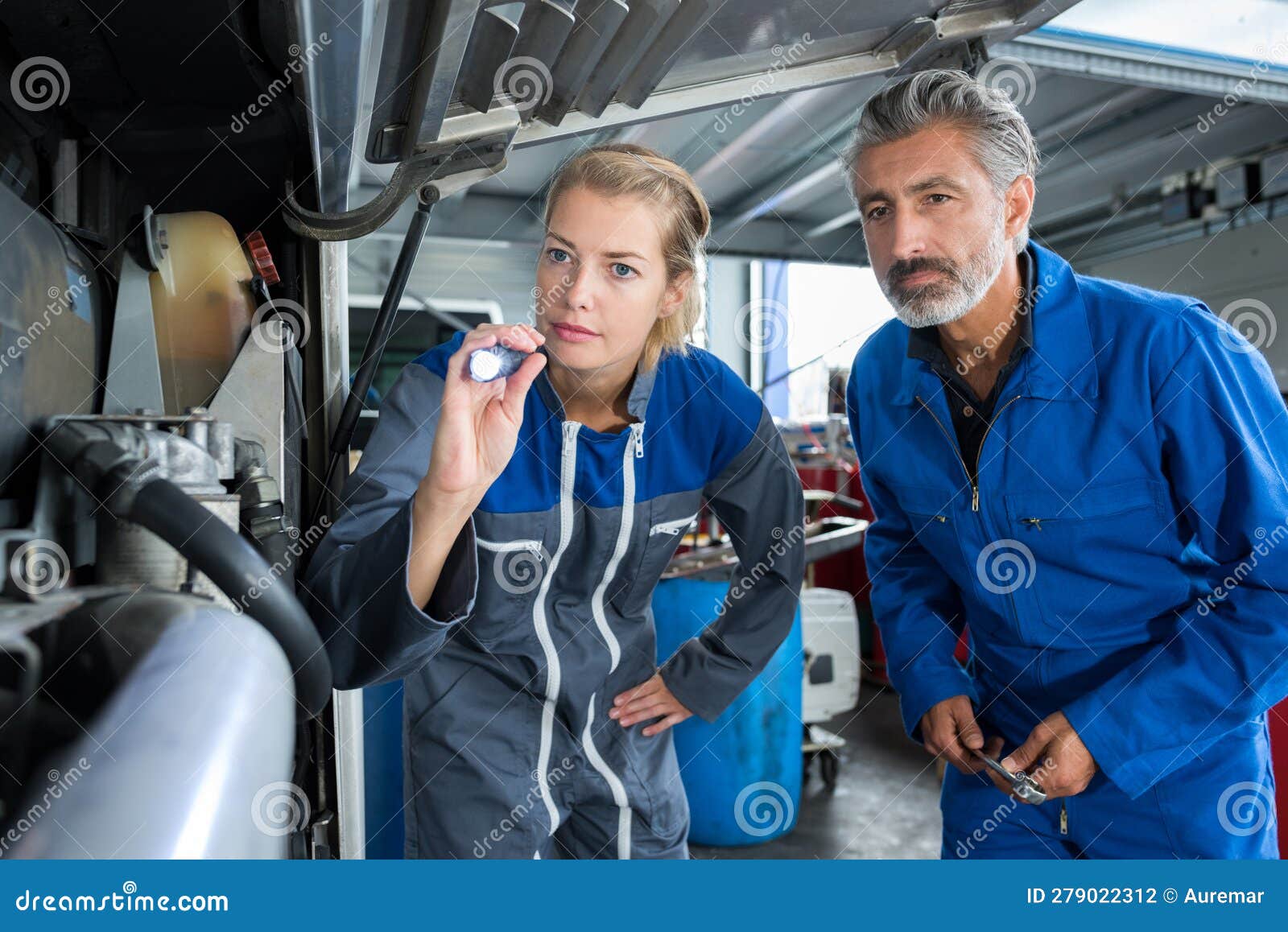 Male and Female Mechanic Team Examine Engine Stock Photo - Image of ...