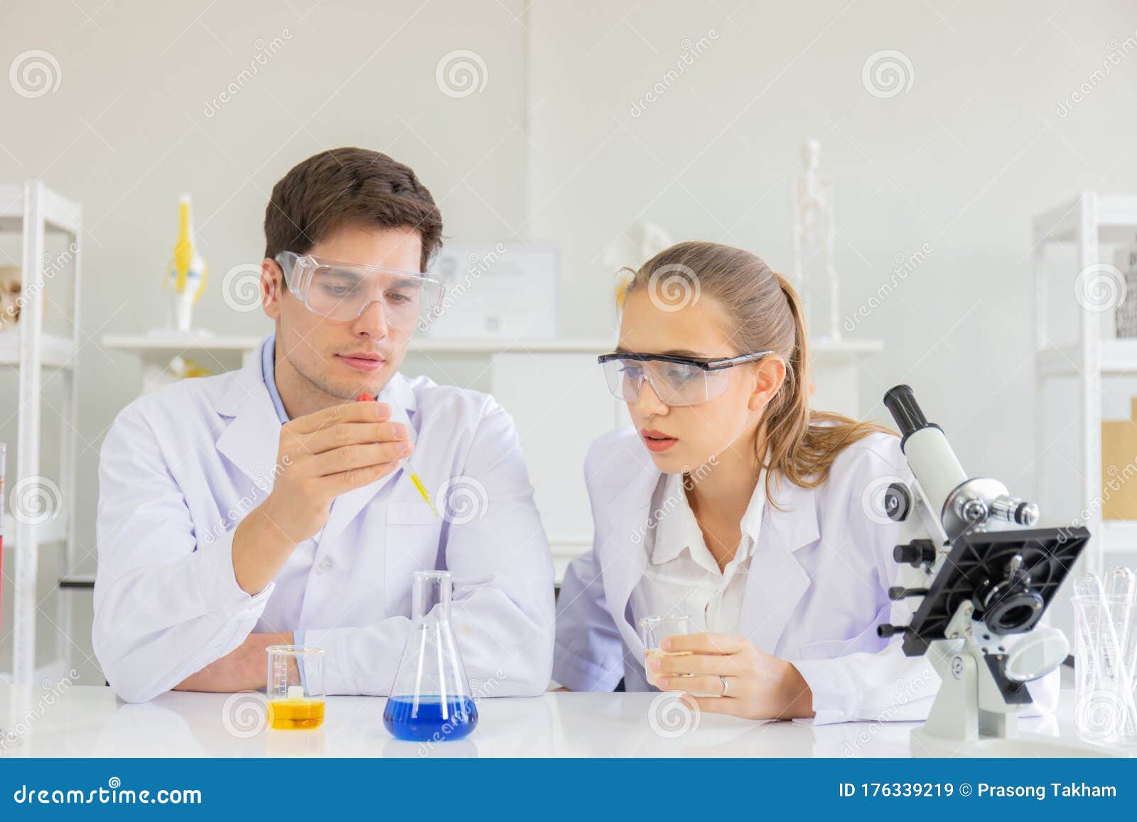 Male and Female Scientists Working in a Science Laboratory with Various ...