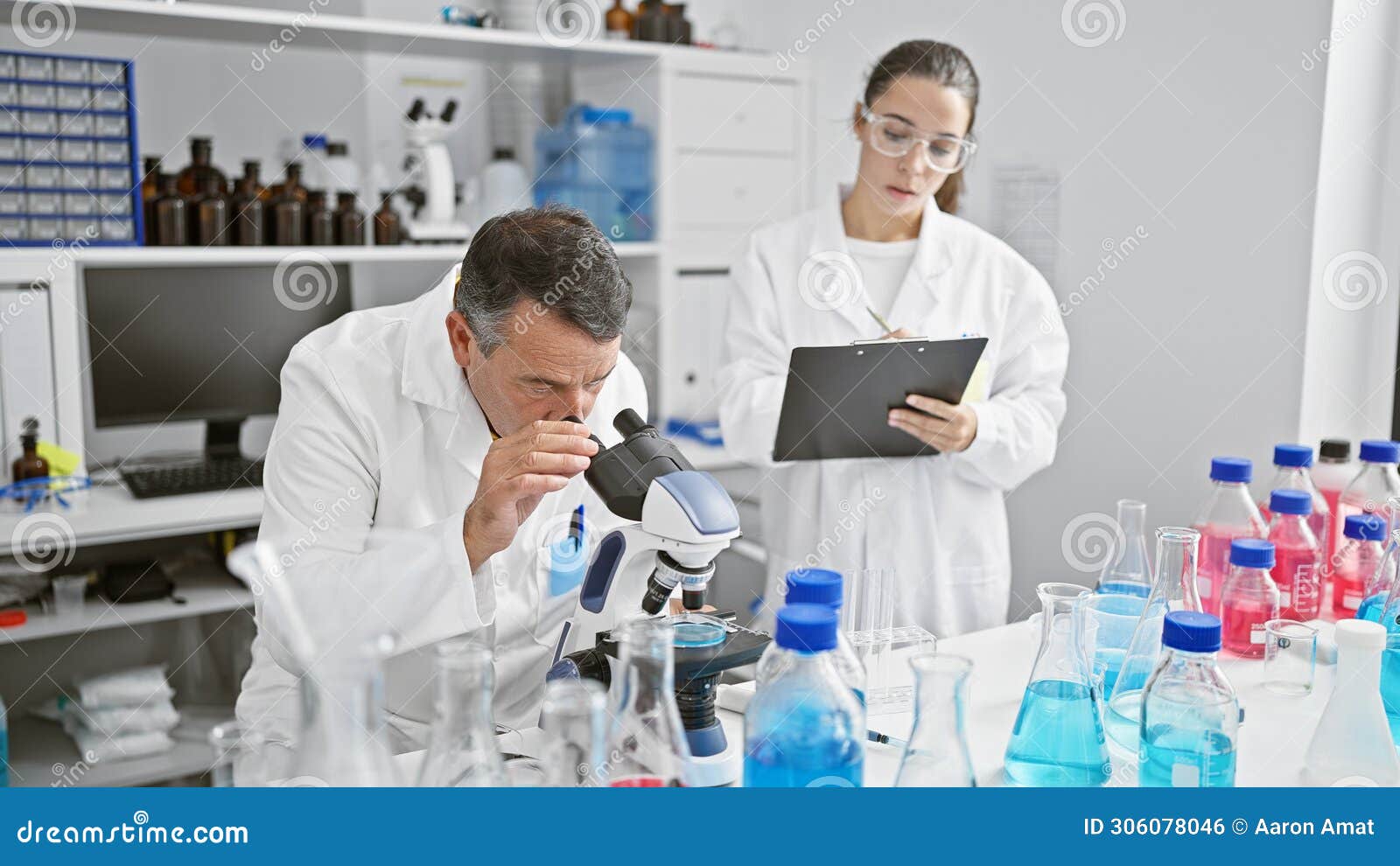 Male and Female Scientists Working Together in Lab, Serious ...