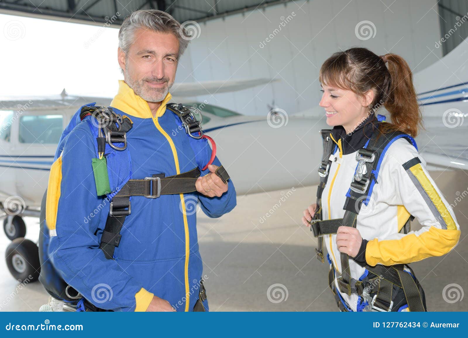 Male and Female Sky Divers Preparing Their Harnesses Stock Photo ...