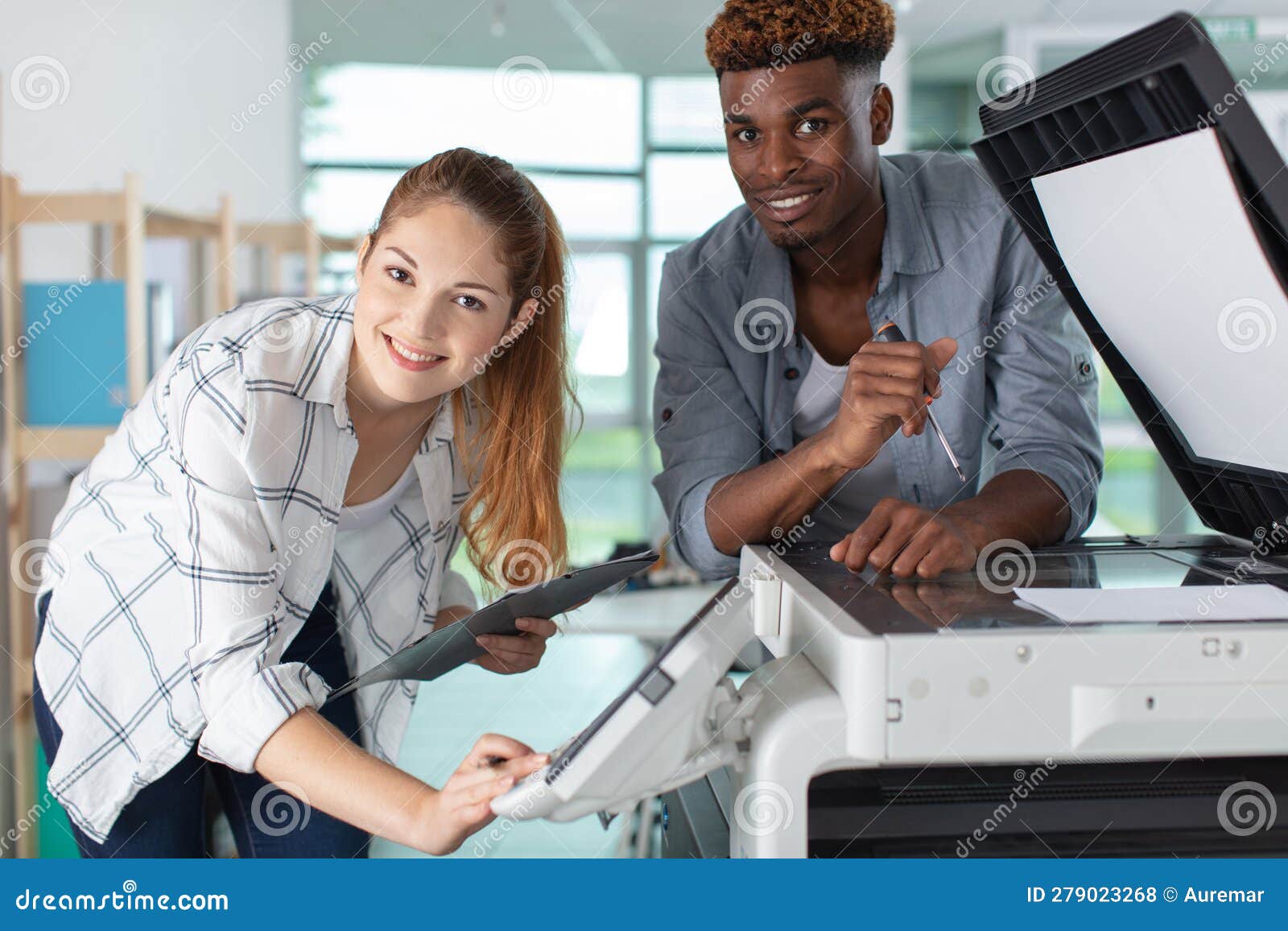 Male and Female Technicians Working on Photocopier Stock Photo - Image ...