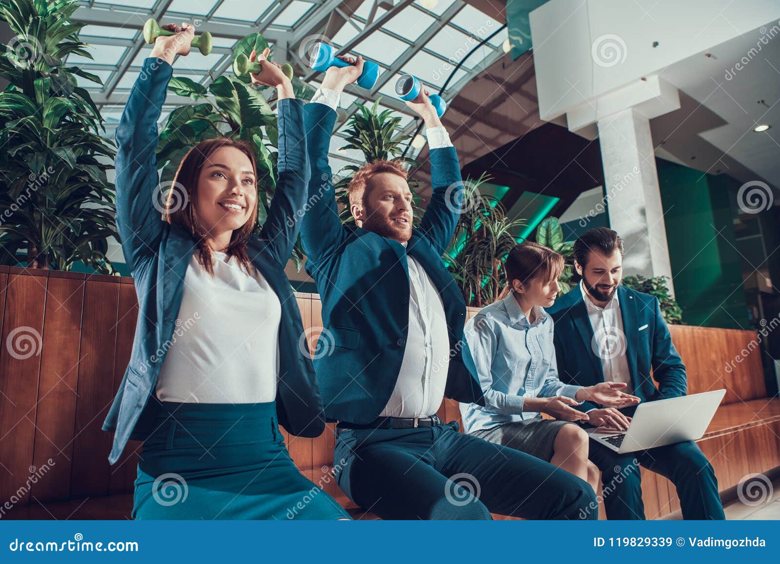 Workers Exercising on Bench in Office. Stock Image - Image of corporate ...