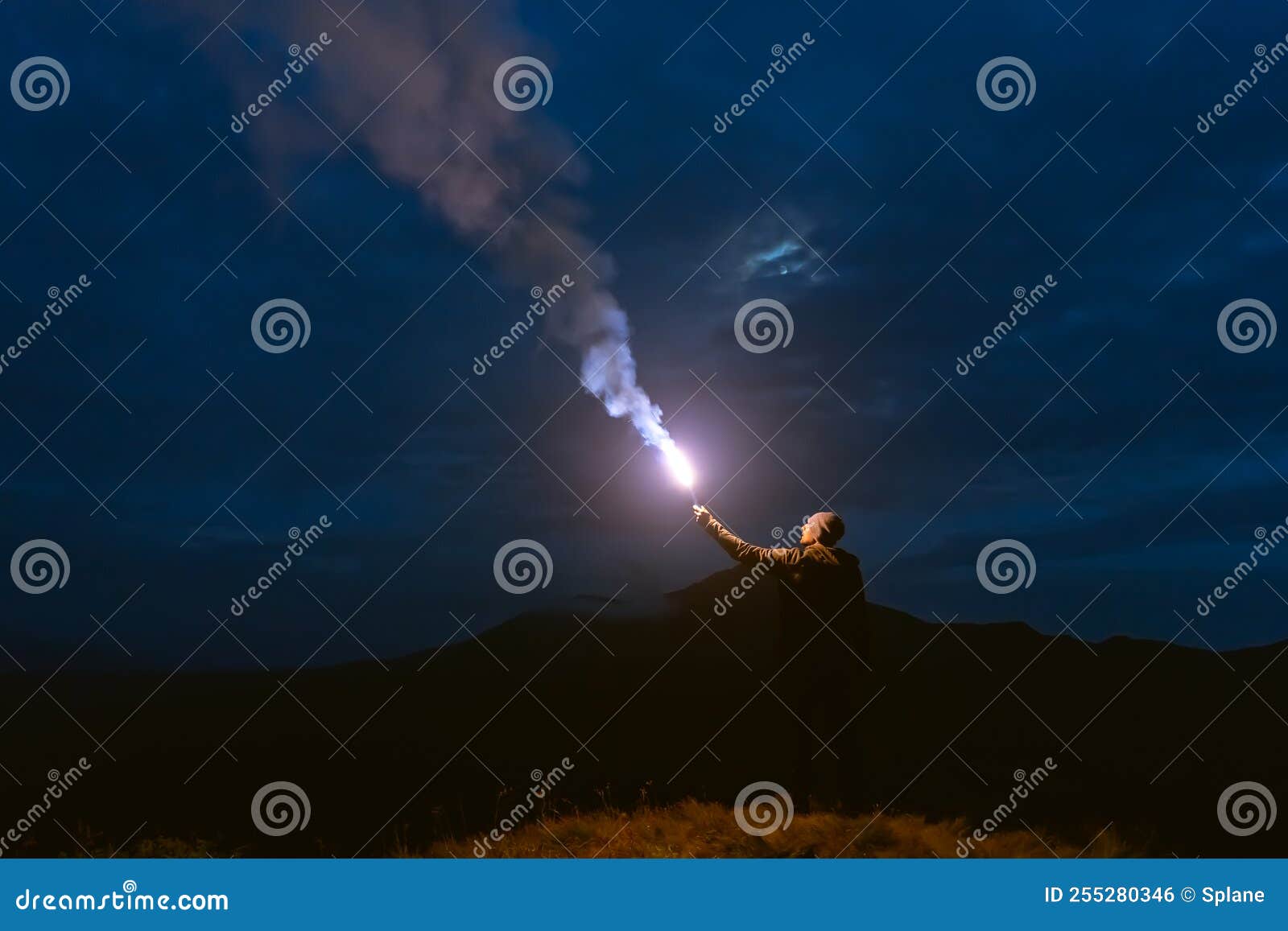 The Male with a Firework Stick Standing on a Mountain. Stock Photo ...