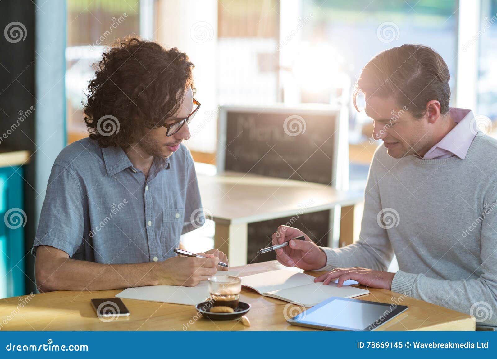 Male Friends Discussing Over Document Stock Image - Image of casual ...