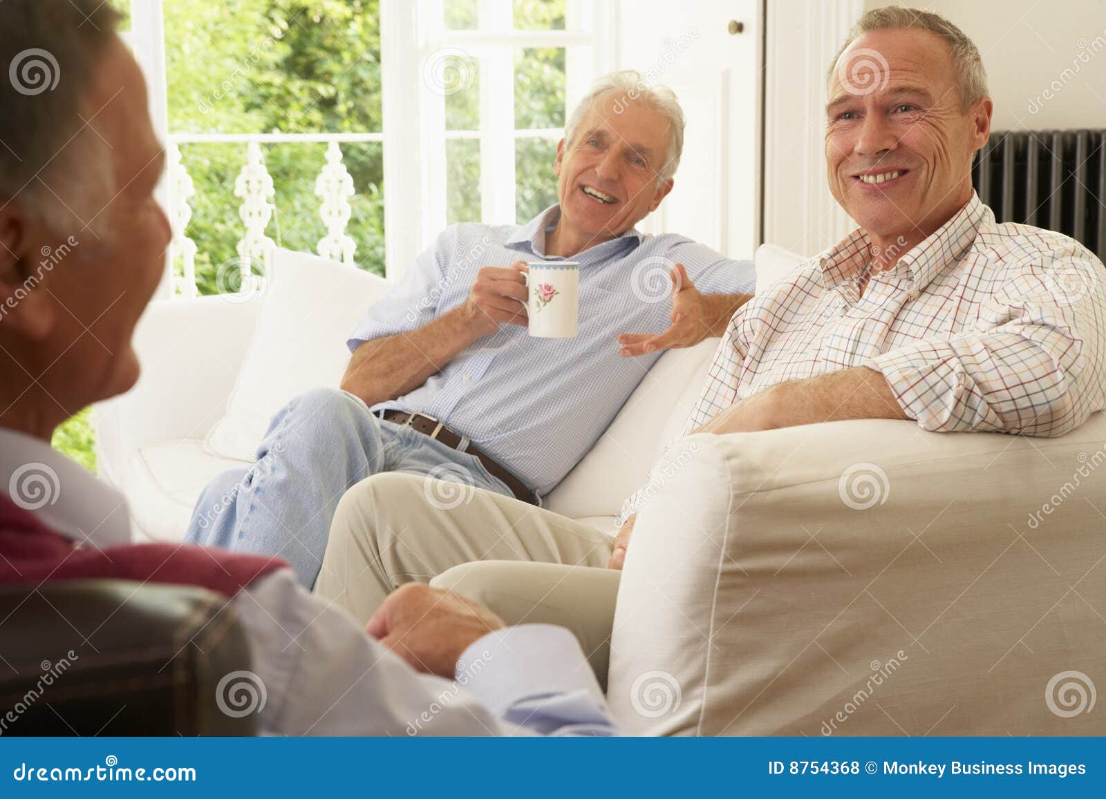 Male Friends Socializing at Home Stock Photo - Image of sixties, adult ...