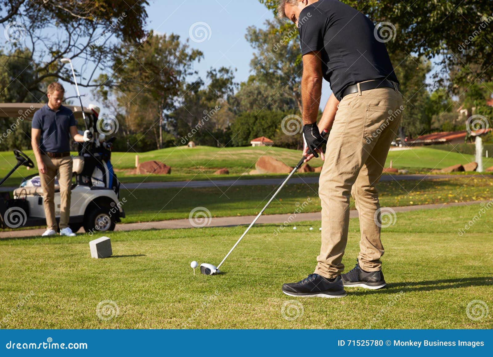 Male Golfer Lining Up Tee Shot on Golf Course Stock Photo - Image of ...