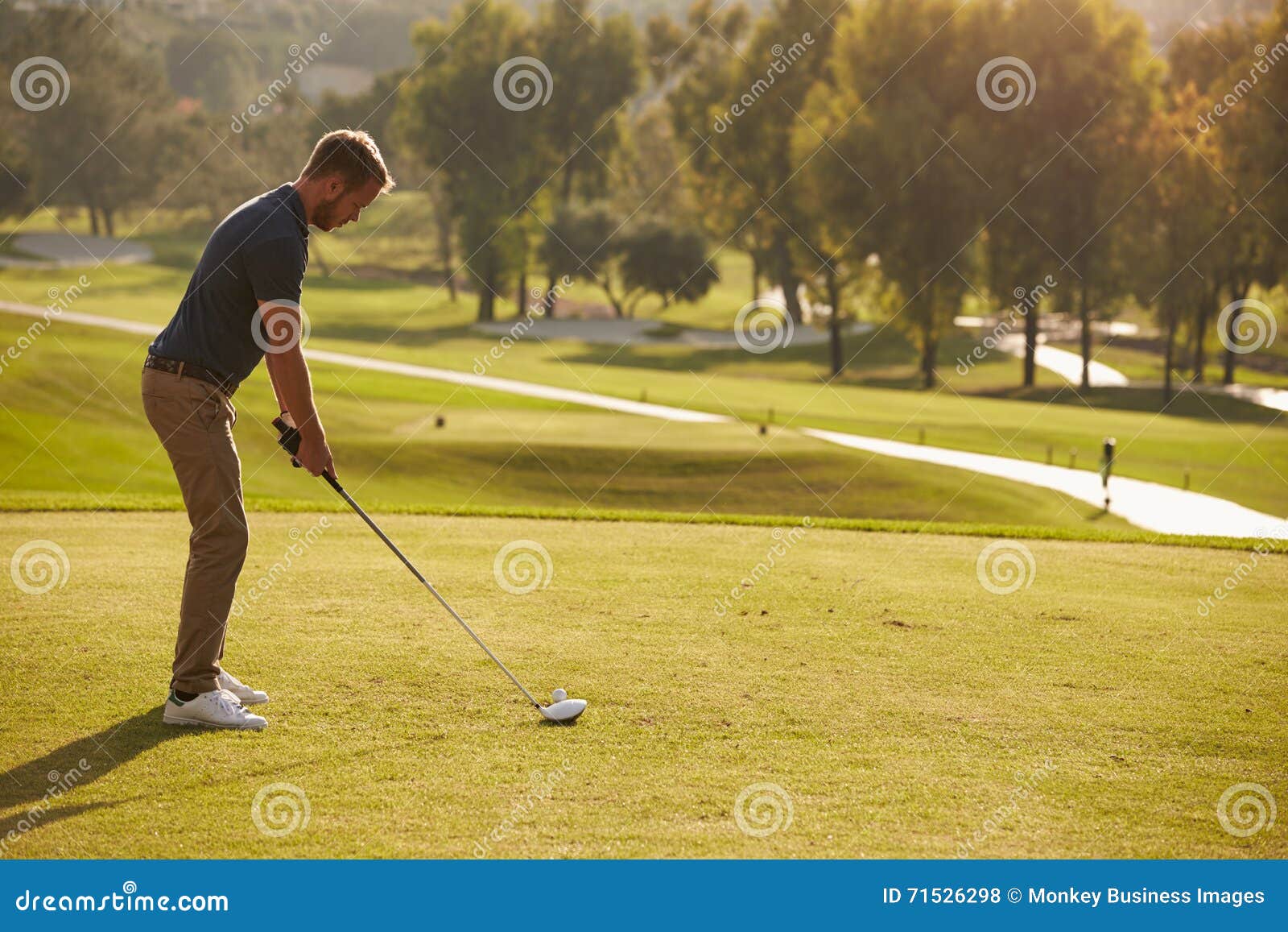 Male Golfer Lining Up Tee Shot on Golf Course Stock Photo - Image of ...