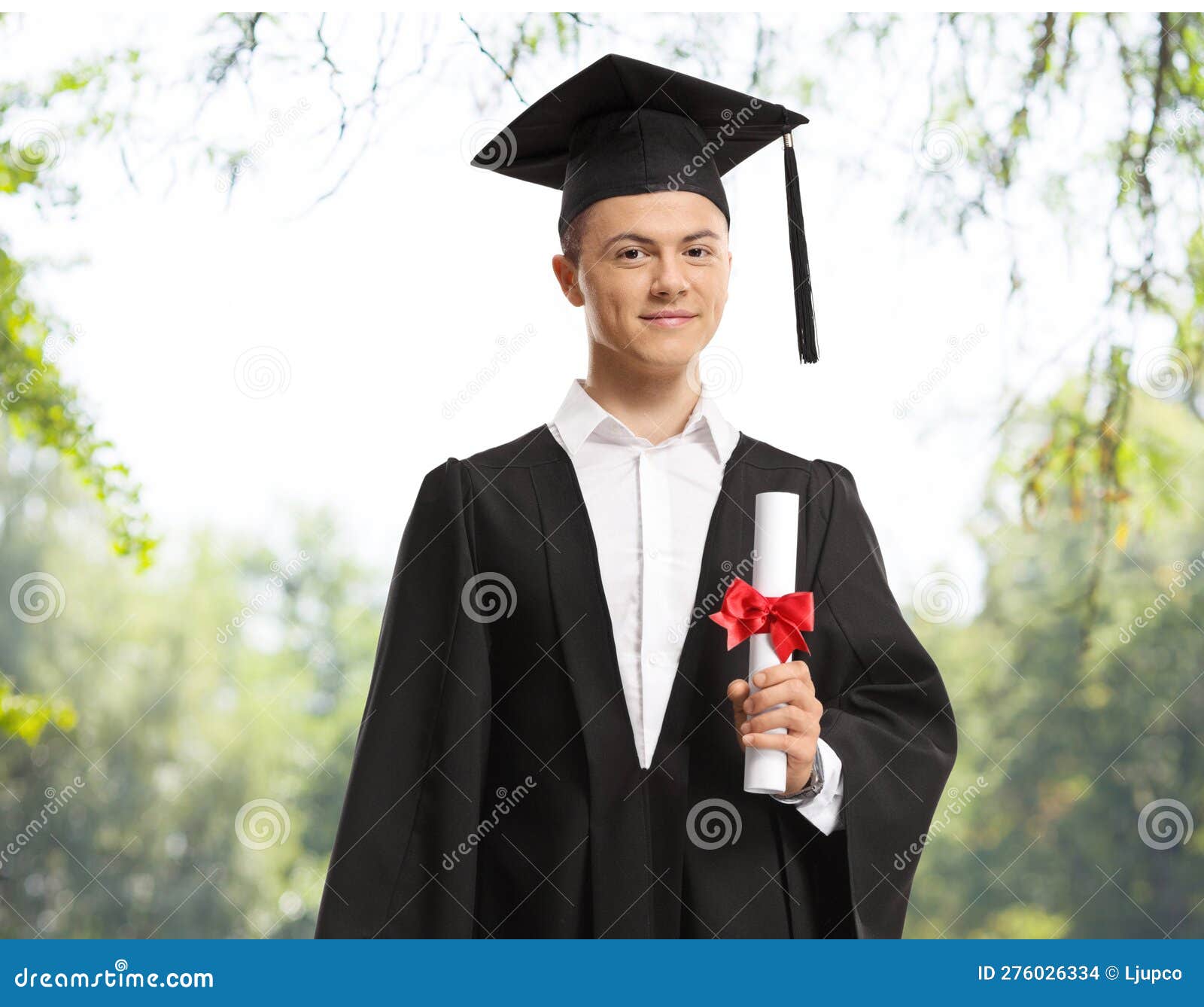 Male Graduate Student Posing in a Park and Holding Diploma Stock Photo ...