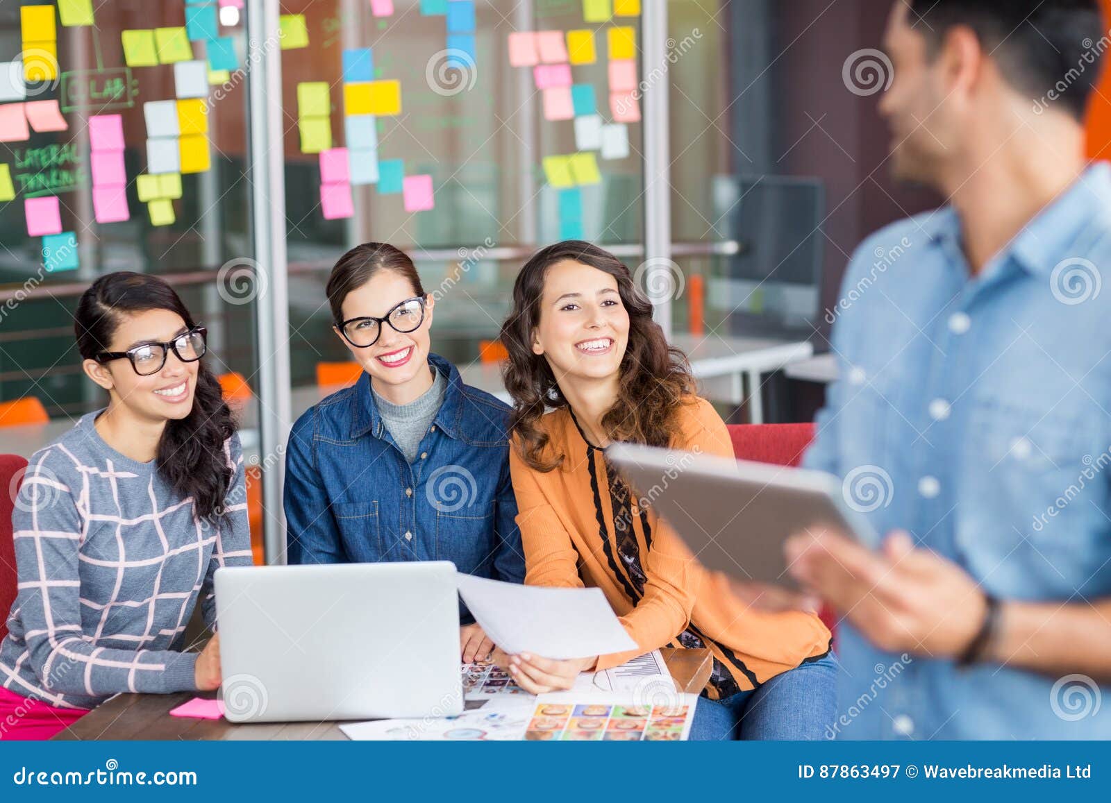 Male Graphic Designer Interacting with His Colleagues Stock Image ...