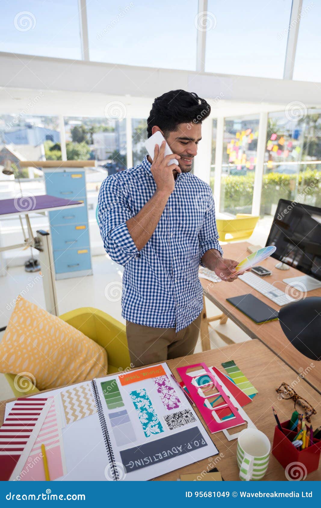 Male Graphic Designer Talking on Mobile Phone at Desk Stock Image ...