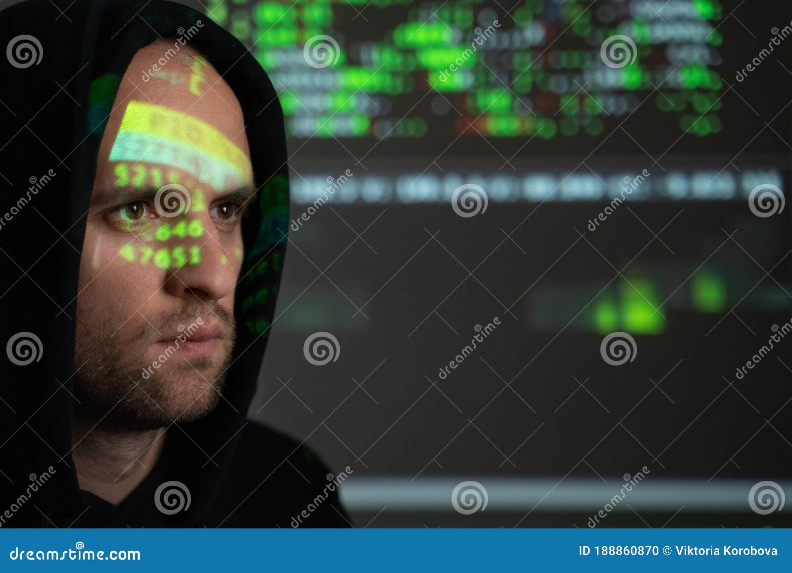 Male Hacker Working on a Computer while Green Code Characters Reflect ... Male Hacker Working on a Computer while Green Code Characters Reflect ...