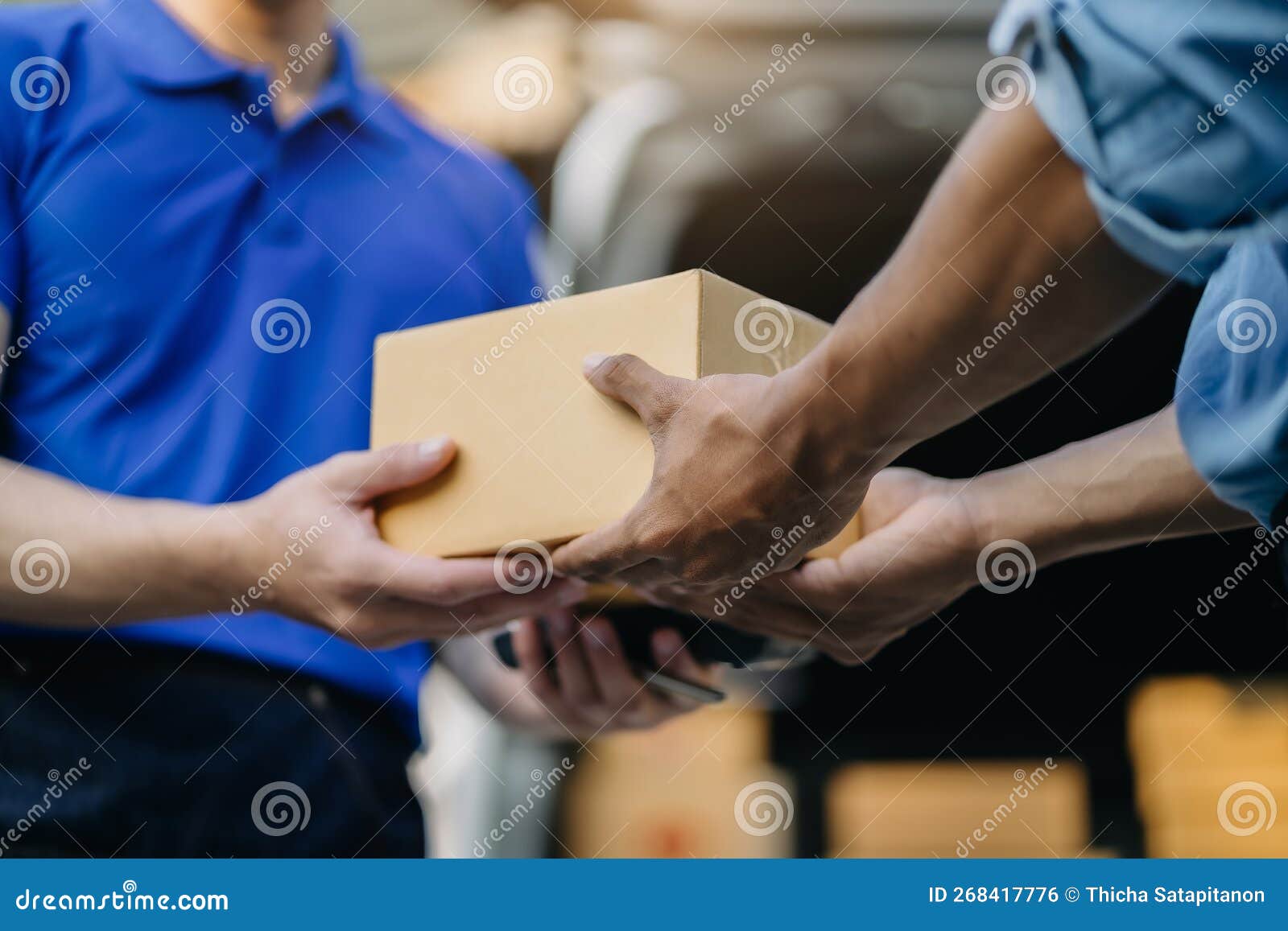 Male Hand Accepting Delivery of Box from Delivery Man in the Morning ...