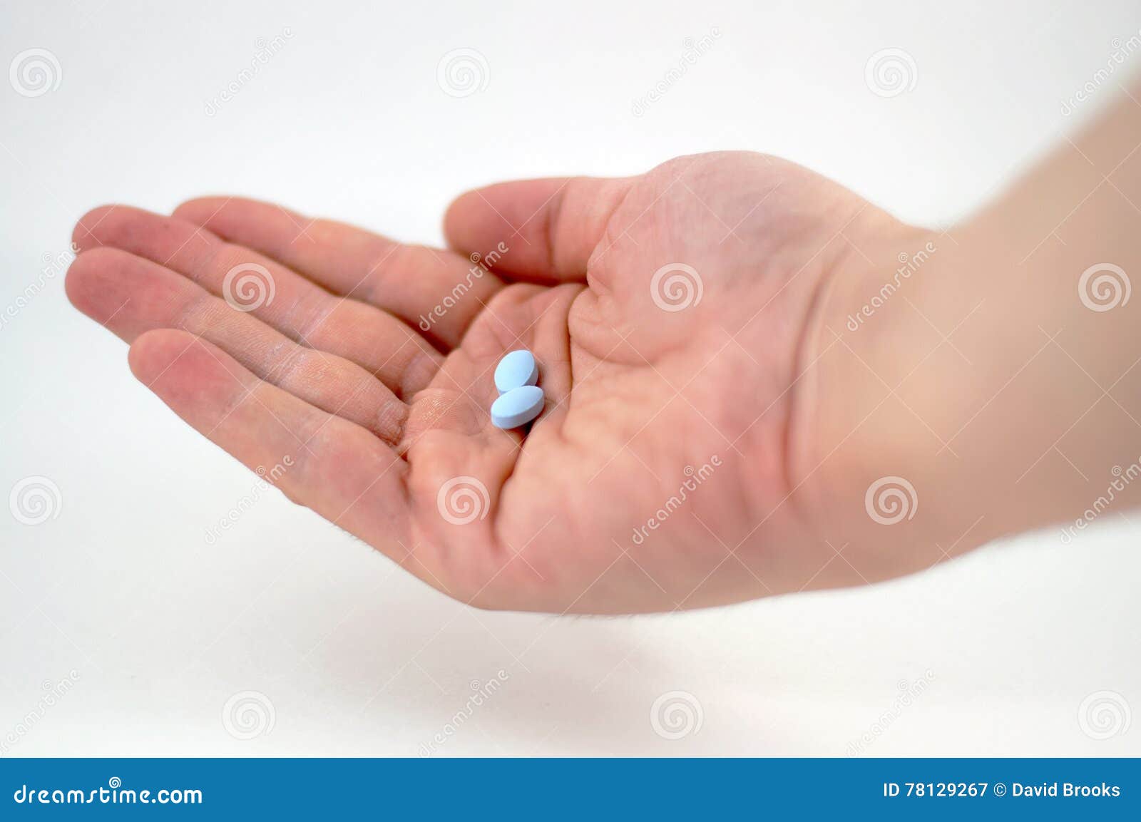 Male hand with blue pills stock image. Image of macro - 78129267
