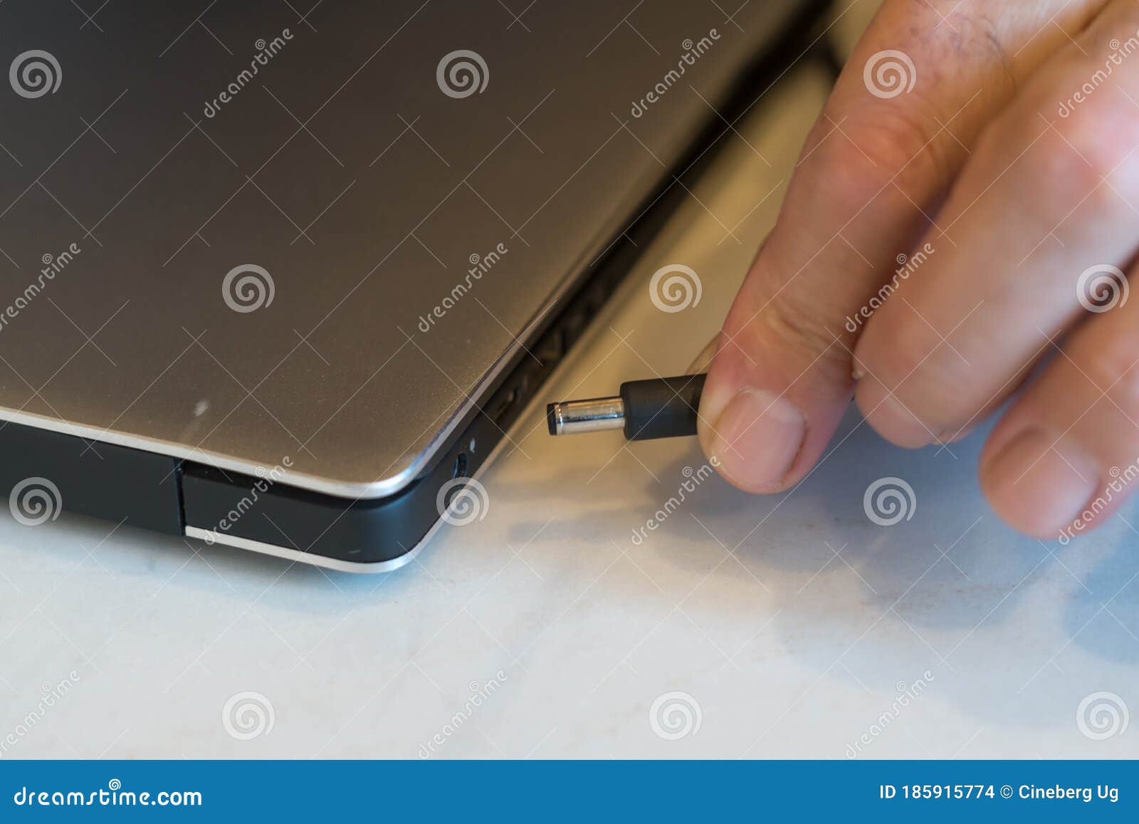 Inserting a charging cable stock photo. Image of computer - 185915774