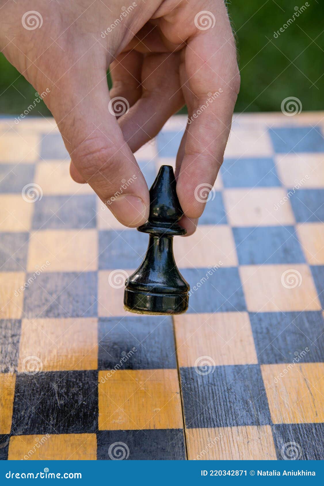 Male Hand Holding One Chess Piece of Black Bishop Over Empty Chessboard ...