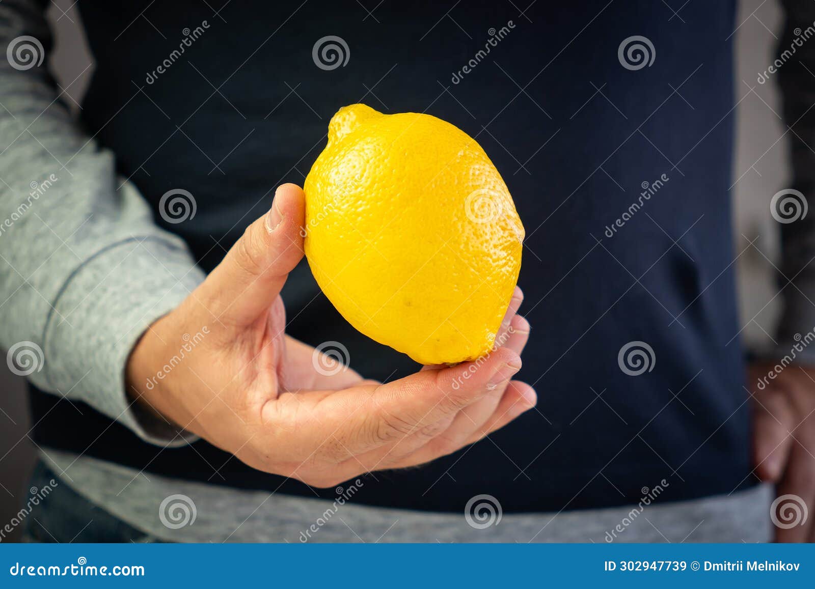 Male Hand Holds a Yellow Lemon. Man Eats a Lemon Stock Image - Image of ...