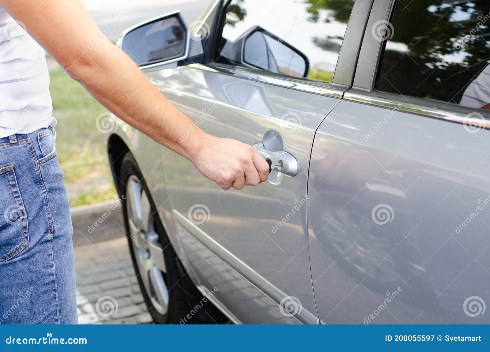 Male Hand Inserting a Key into the Door Lock of a Car Stock Image ...
