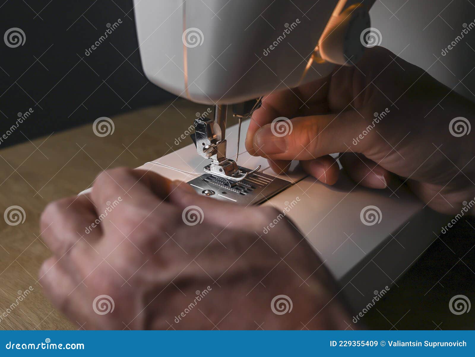 Male Hand Inserting Thread into Needle of Sewing Machine Stock Image ...