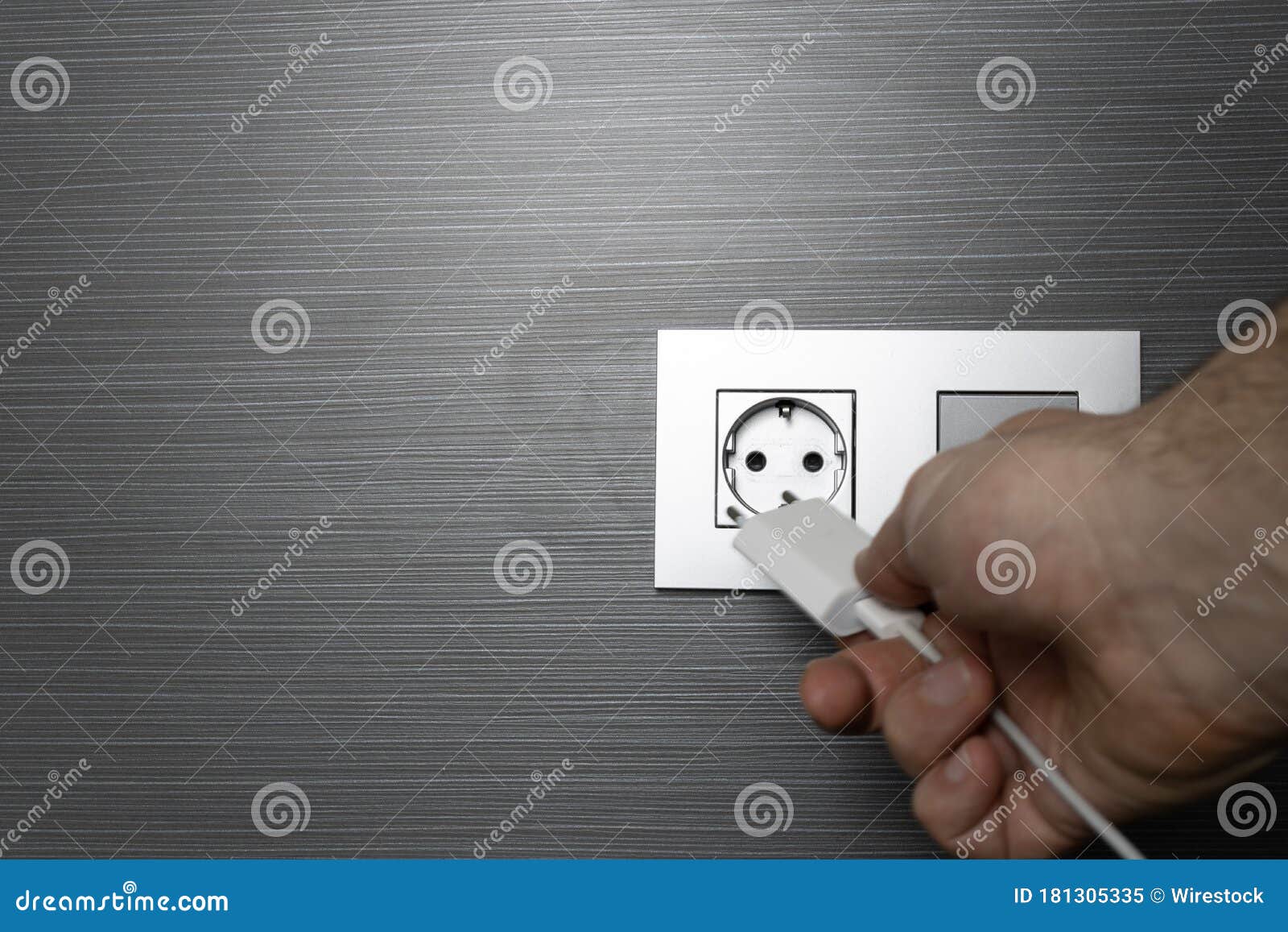 Male Hand Plugging in a White Charger on a Grey Wall Stock Image ...