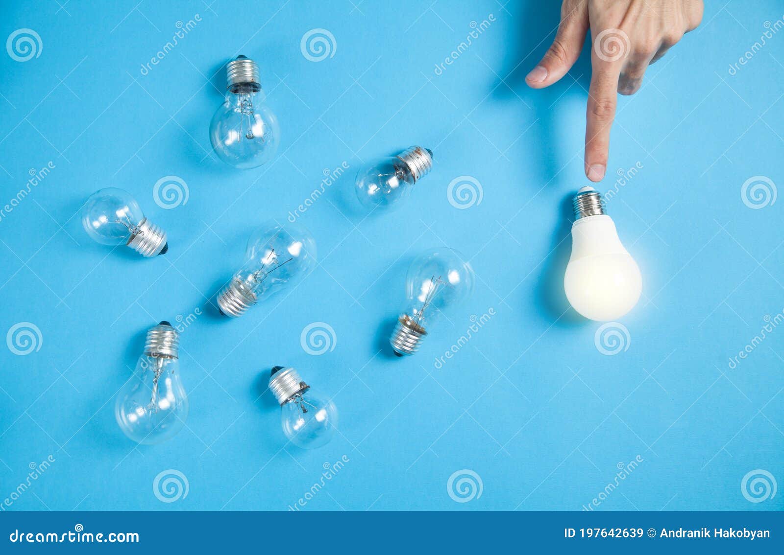 Male Hand Pointing Light Bulb in the Blue Background Stock Image ...