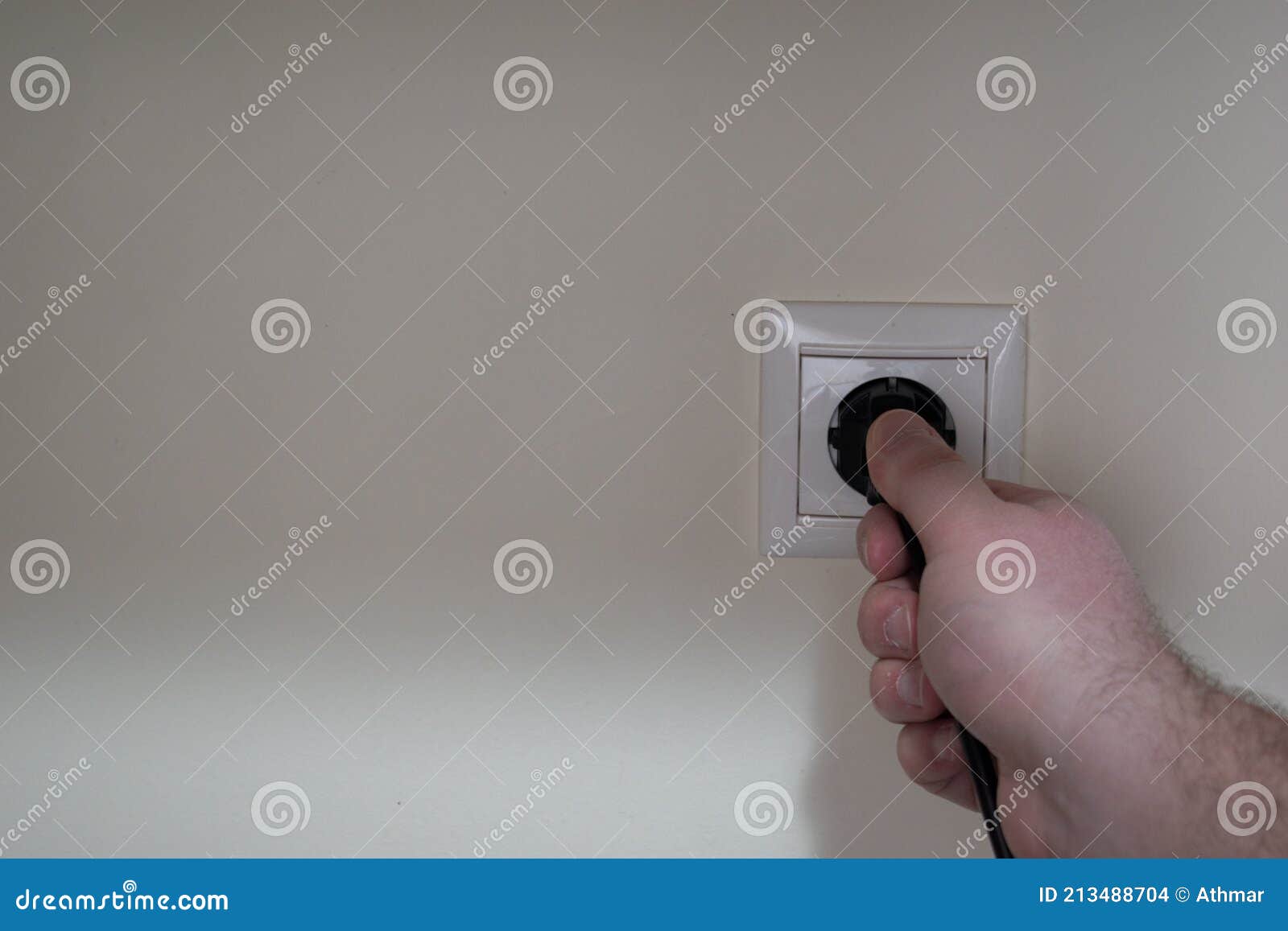 Pulling An Electrical Cable Out Of A Wall Socket To Save Energy Royalty ...