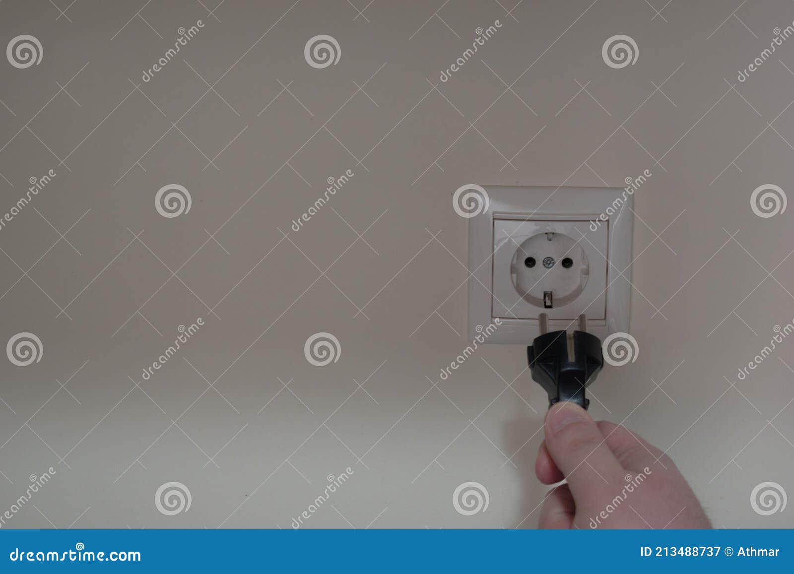 Pulling An Electrical Cable Out Of A Wall Socket To Save Energy Royalty ...