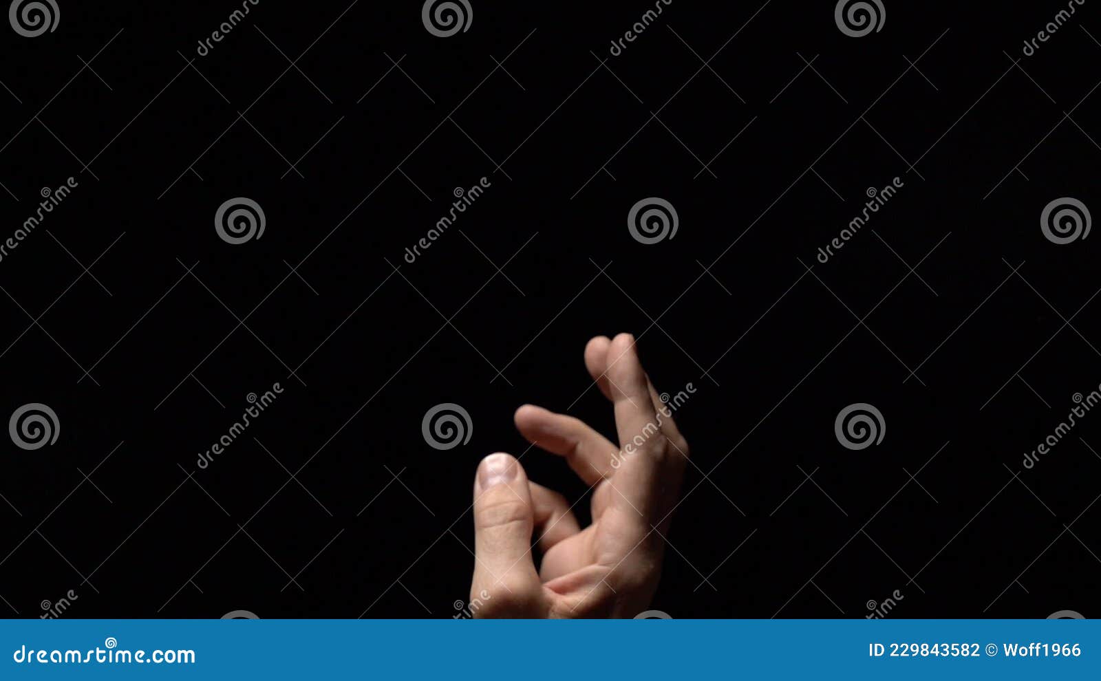 Male Hand Reaching Out To Light on Black Background Stock Footage ...