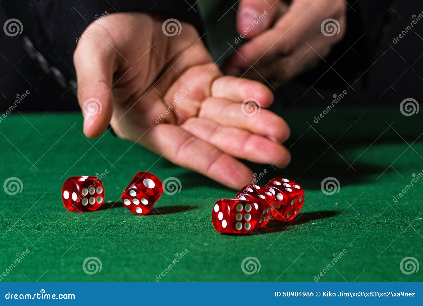 Hand Rolling Dice On Table