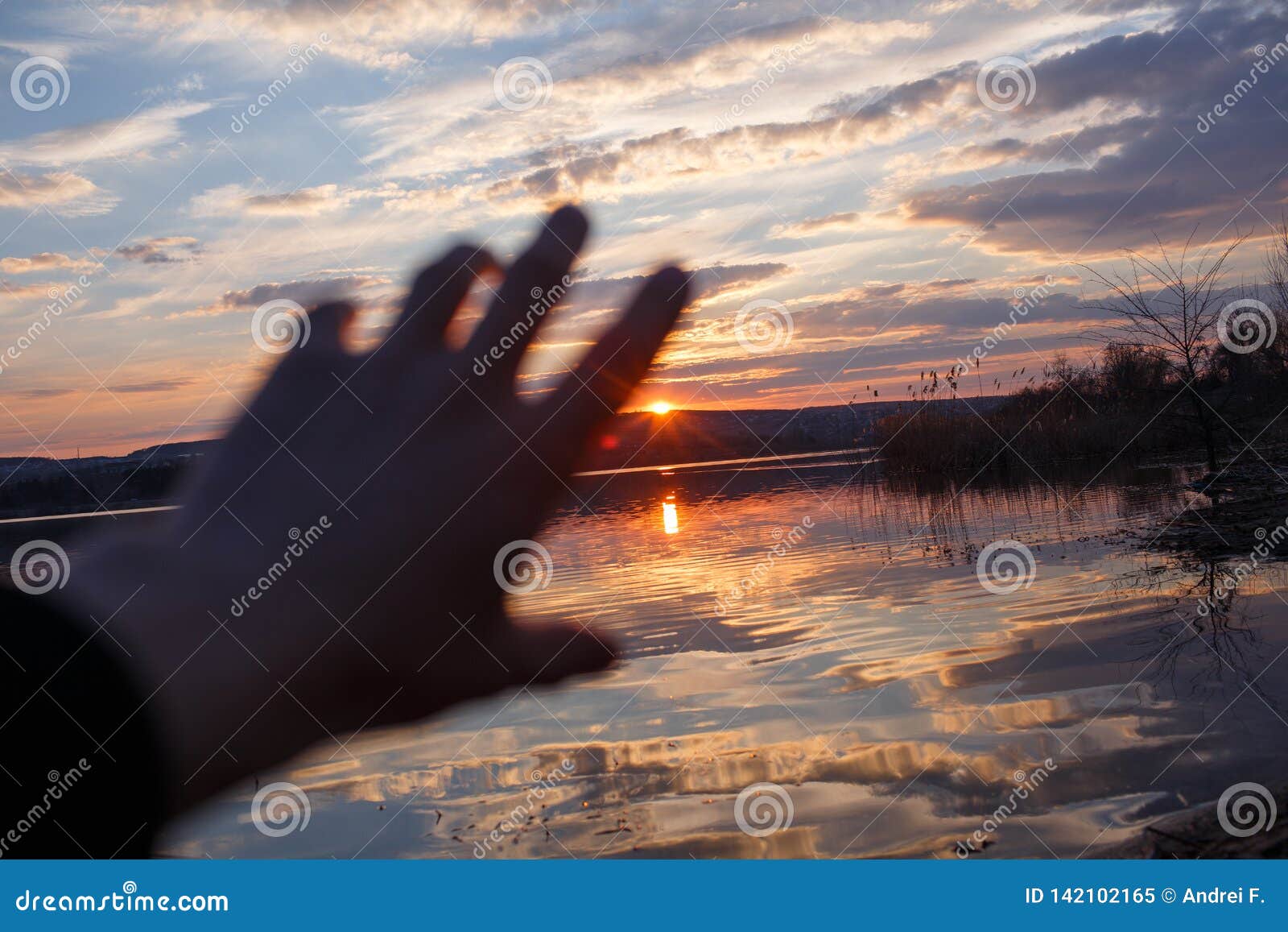 Male Hand is Touching the Sunset Over Lake. Stock Image - Image of ...