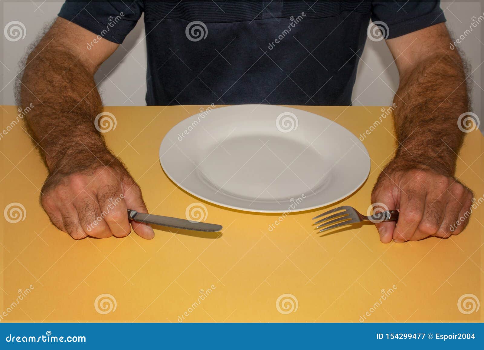 Male Hands with a Knife and Fork are Lying on the Table in Front of an ...