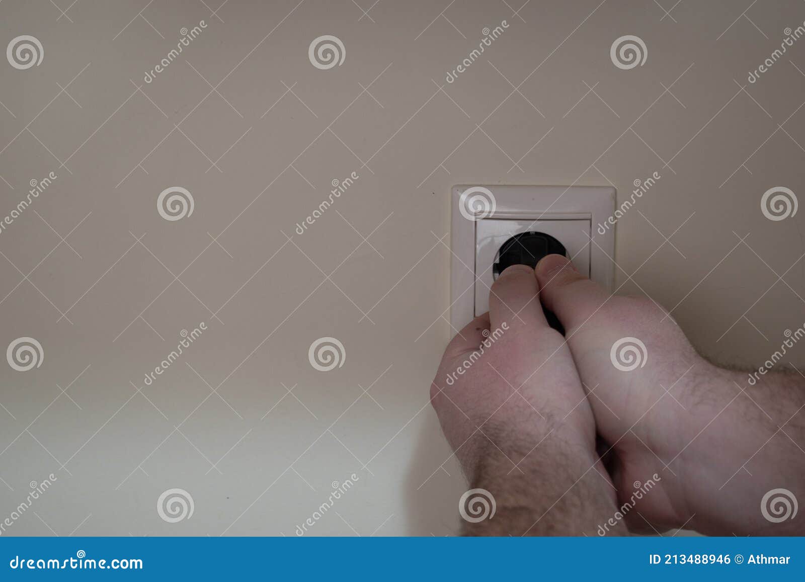 Pulling An Electrical Cable Out Of A Wall Socket To Save Energy Royalty ...