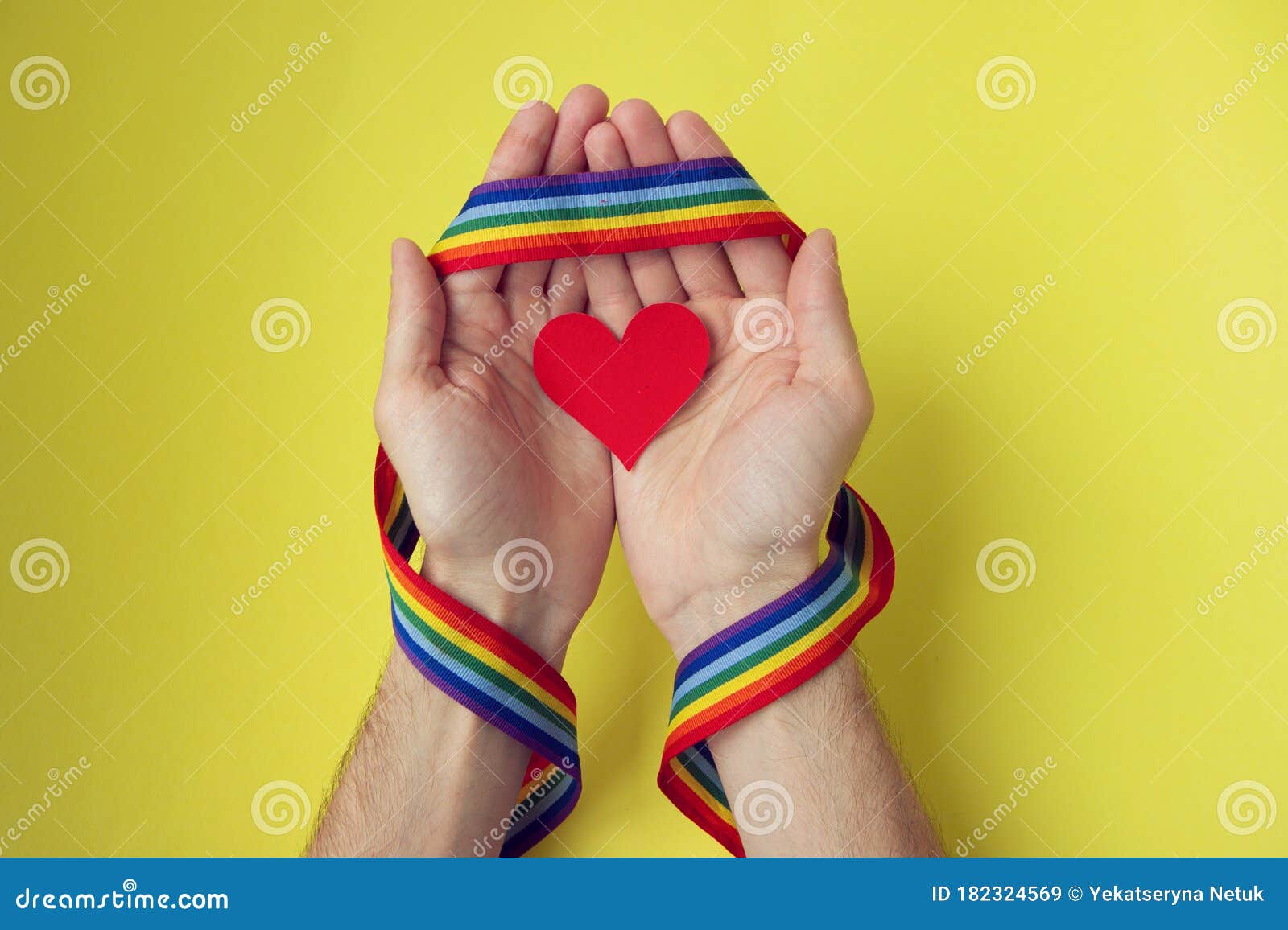 Male Hands With Rainbow Gay Pride Lgbt Ribbon Wristband Holding Paper