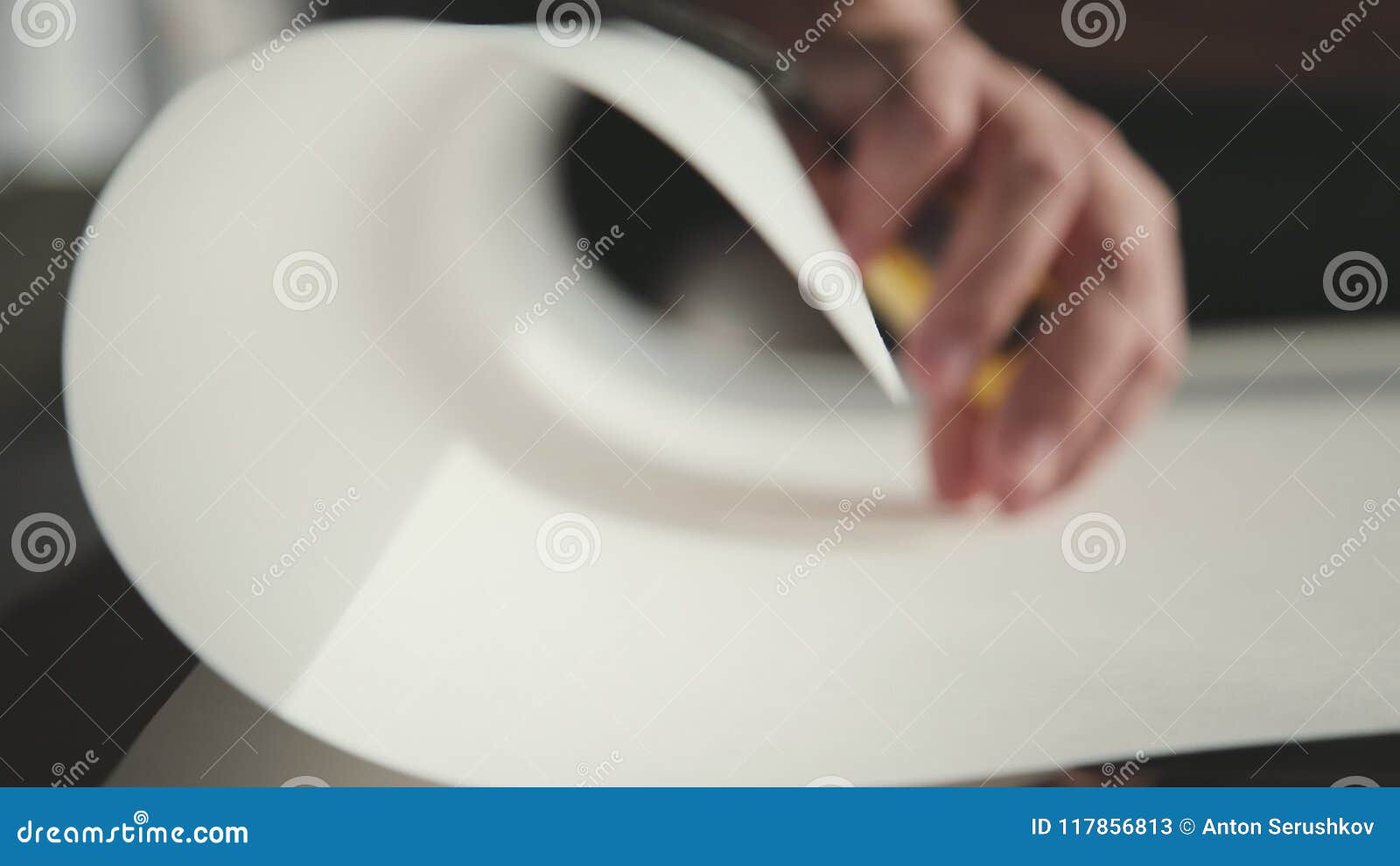 Male Hands Unfold the Roll with Drawings. Process of Unfolding Paper ...