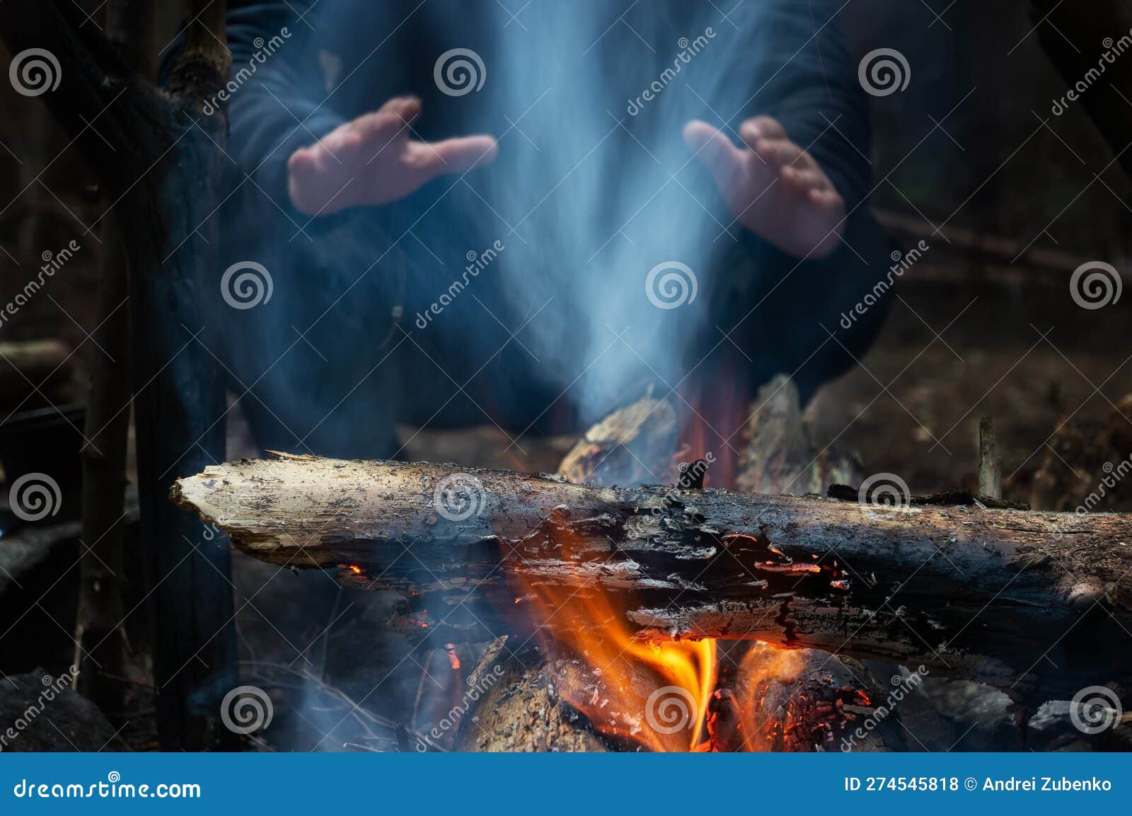 Male Hands are Warming by the Fire. a Hot Fire in the Camp Keeps ...