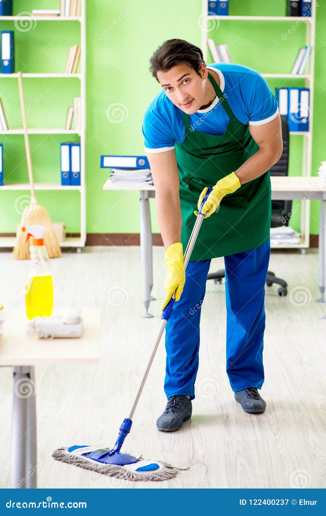 The Male Handsome Professional Cleaner Doing Mopping in the Office ...