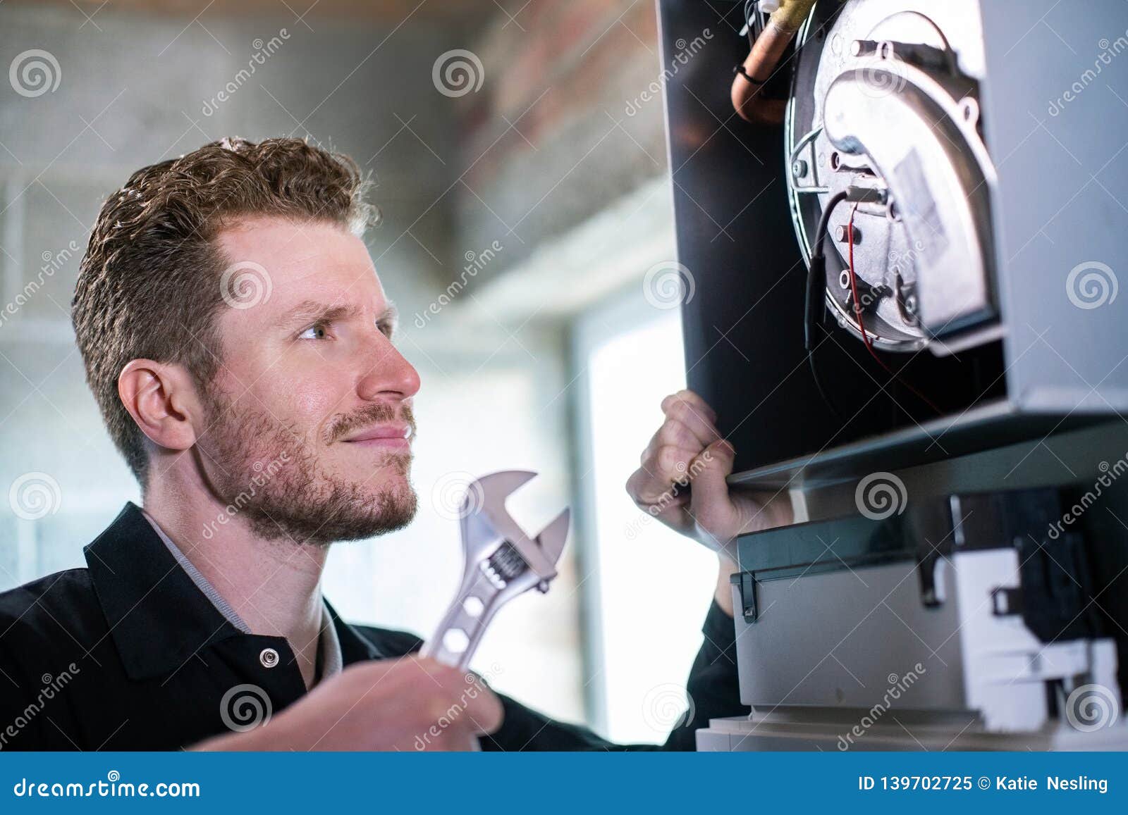 Male Heating Engineer with Adjustable Wrench Servicing Boiler Stock ...