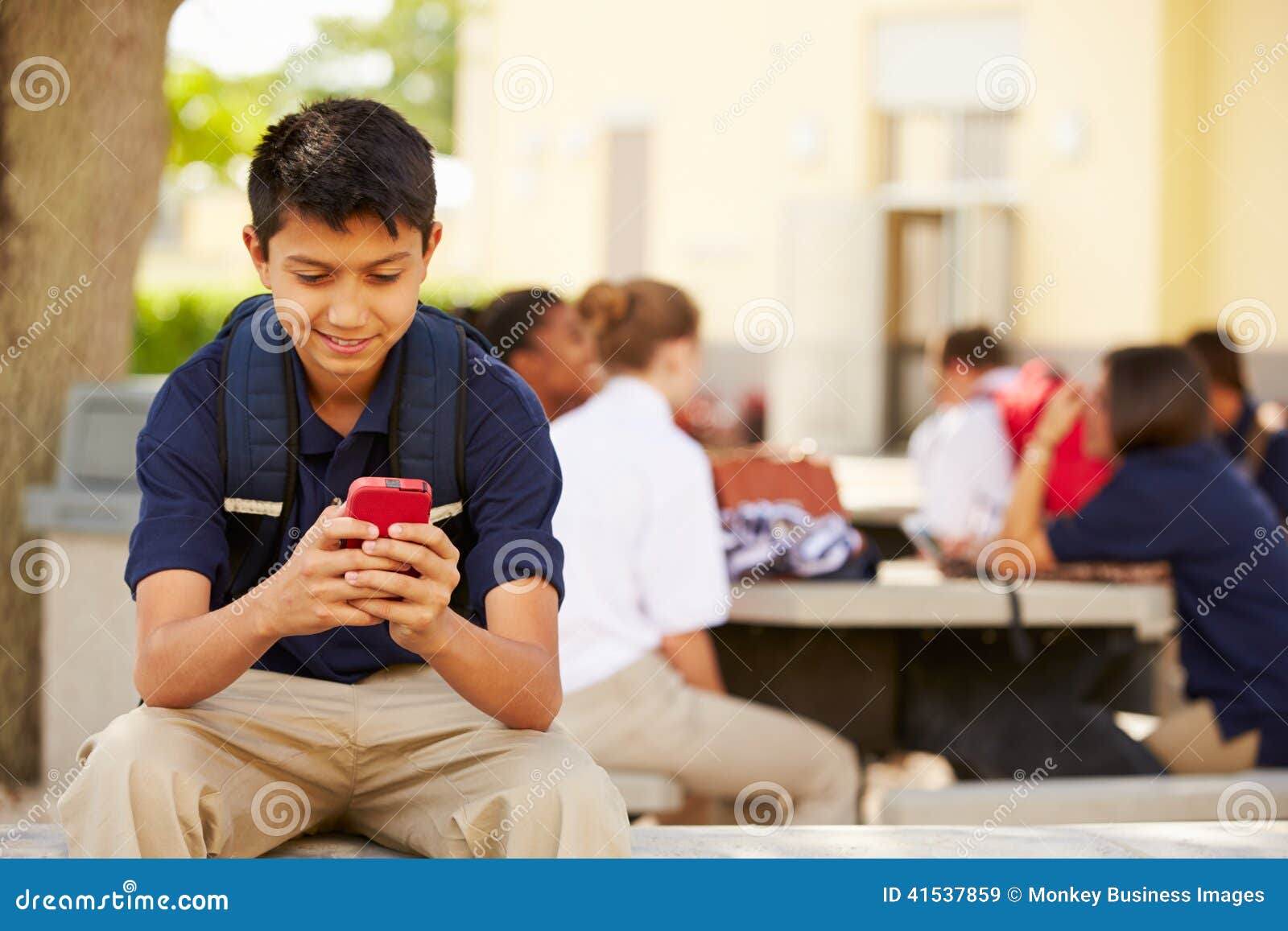 Male High School Student Using Phone on School Campus Stock Image ...