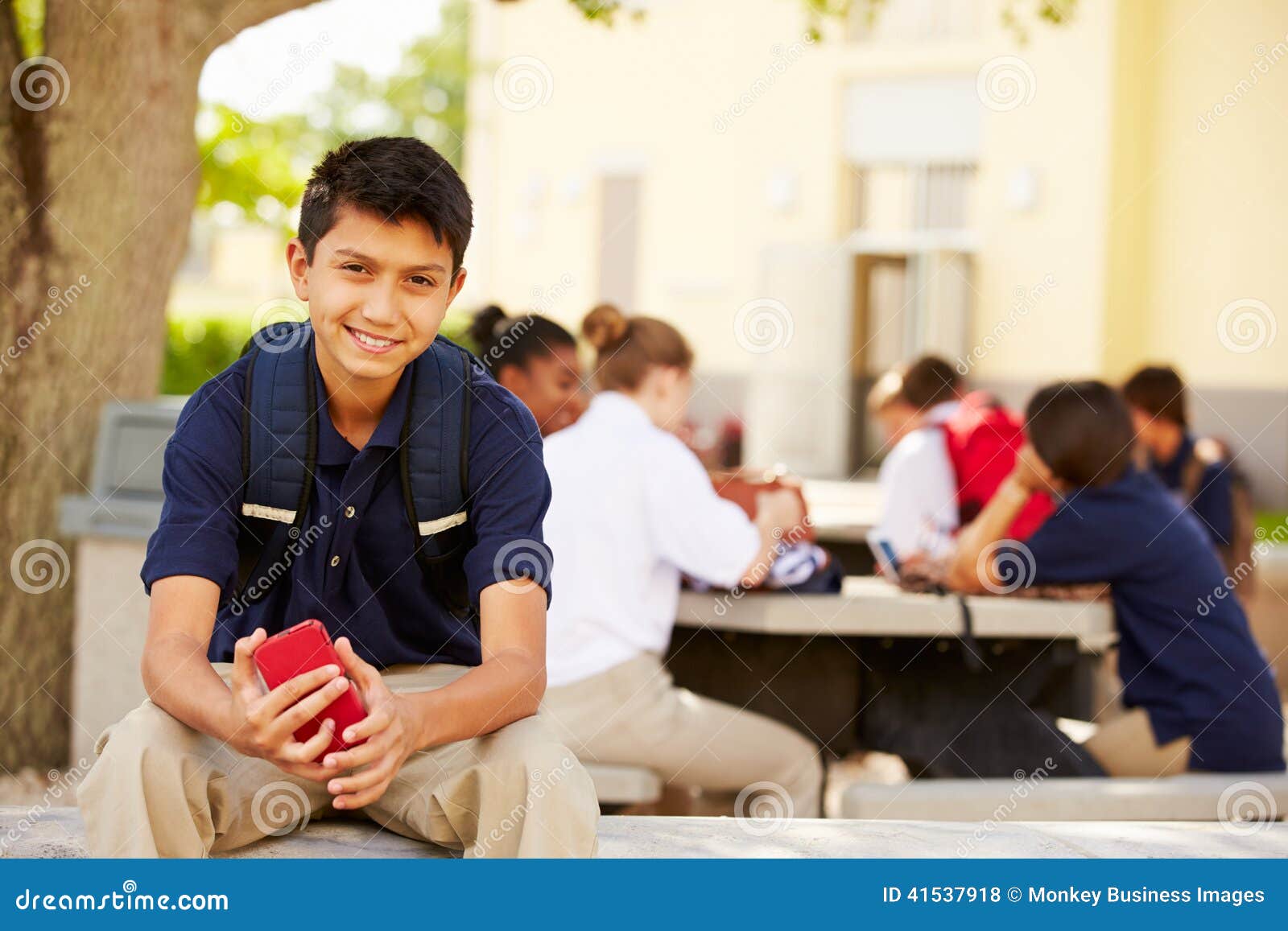 Male High School Student Using Phone on School Campus Stock Photo ...