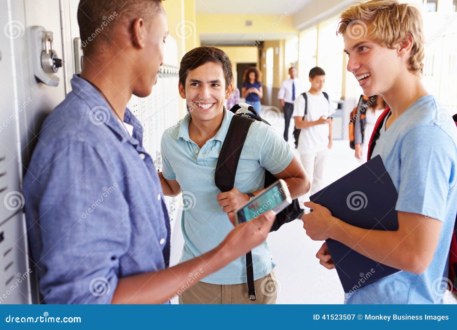 Male High School Student Asking Teacher Question In Design And ...