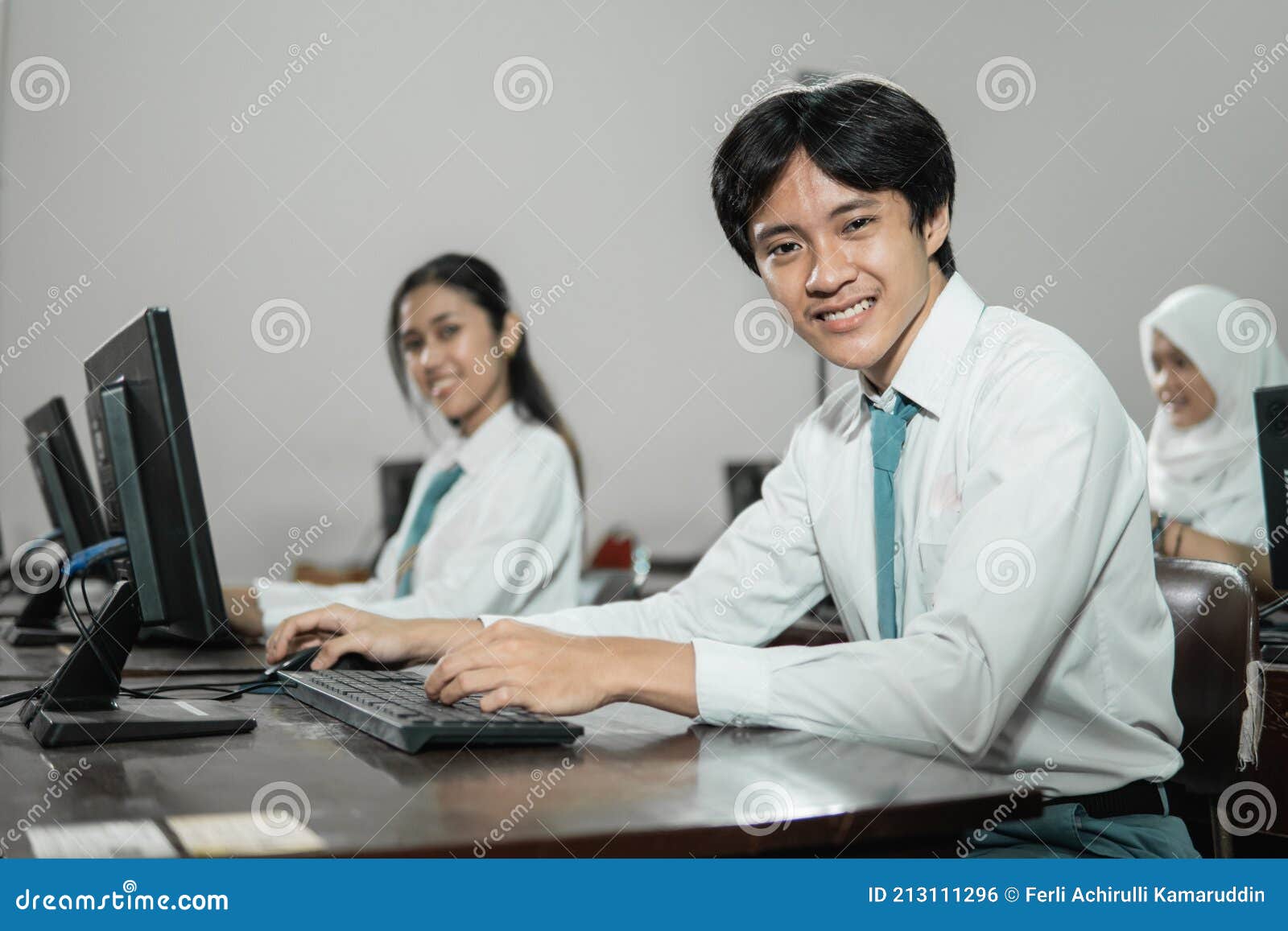 Male High School Students Smile Looking at the Camera while Using a ...