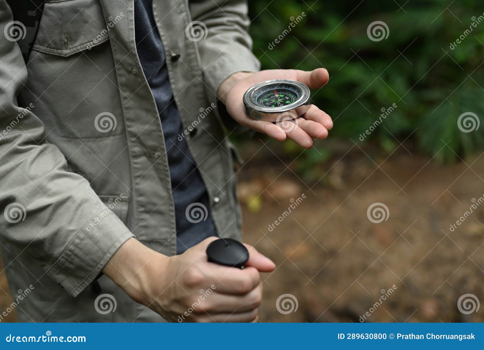 Male Hiker Using Compass for Directions in the Forest, Enjoying His ... Male Hiker Using Compass for Directions in the Forest, Enjoying His ...