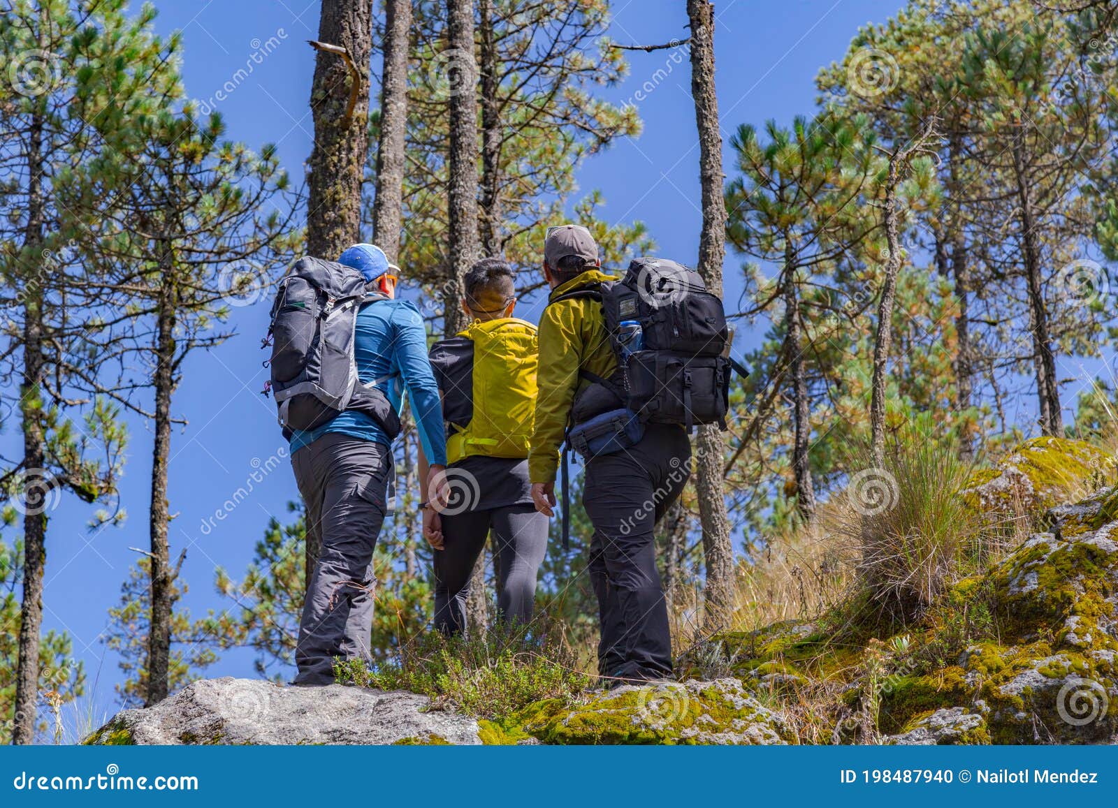 Male Hikers Climbing Up Mountain Cliff Team Work Concept Stock Photo ...