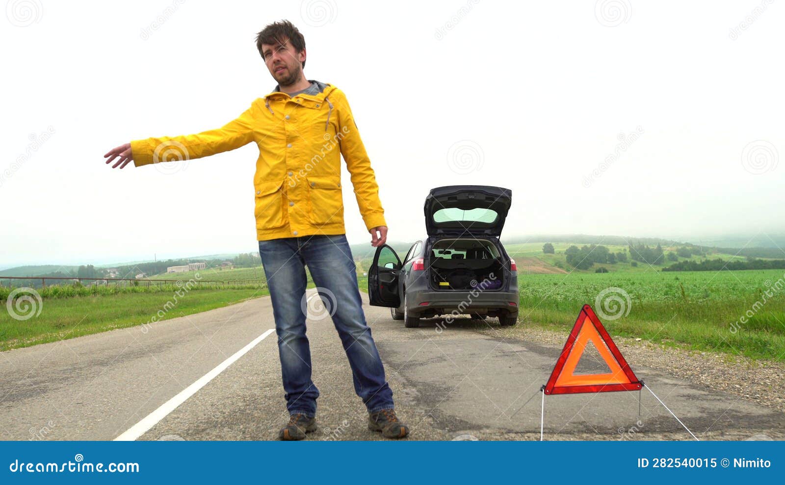 Male with His Broken Down Car with Hazard Lights Put Emergency Marker ...