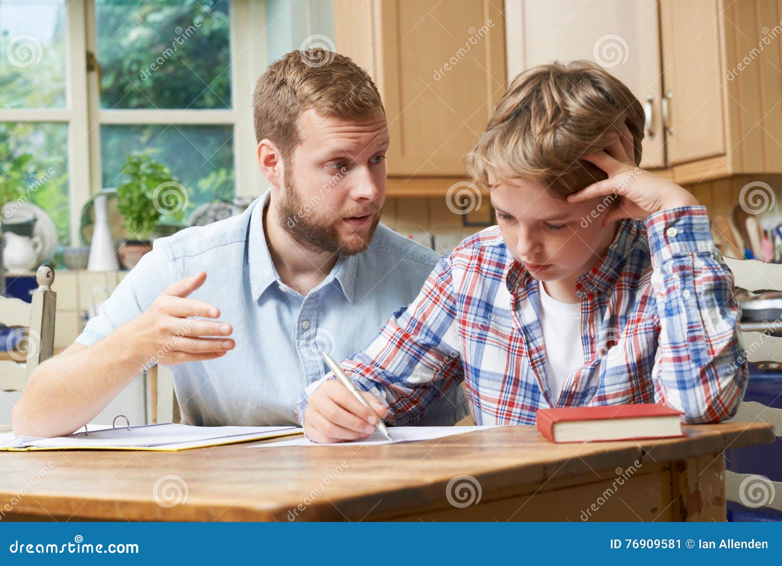 Male Home Tutor Helping Boy with Studies Stock Image - Image of ...