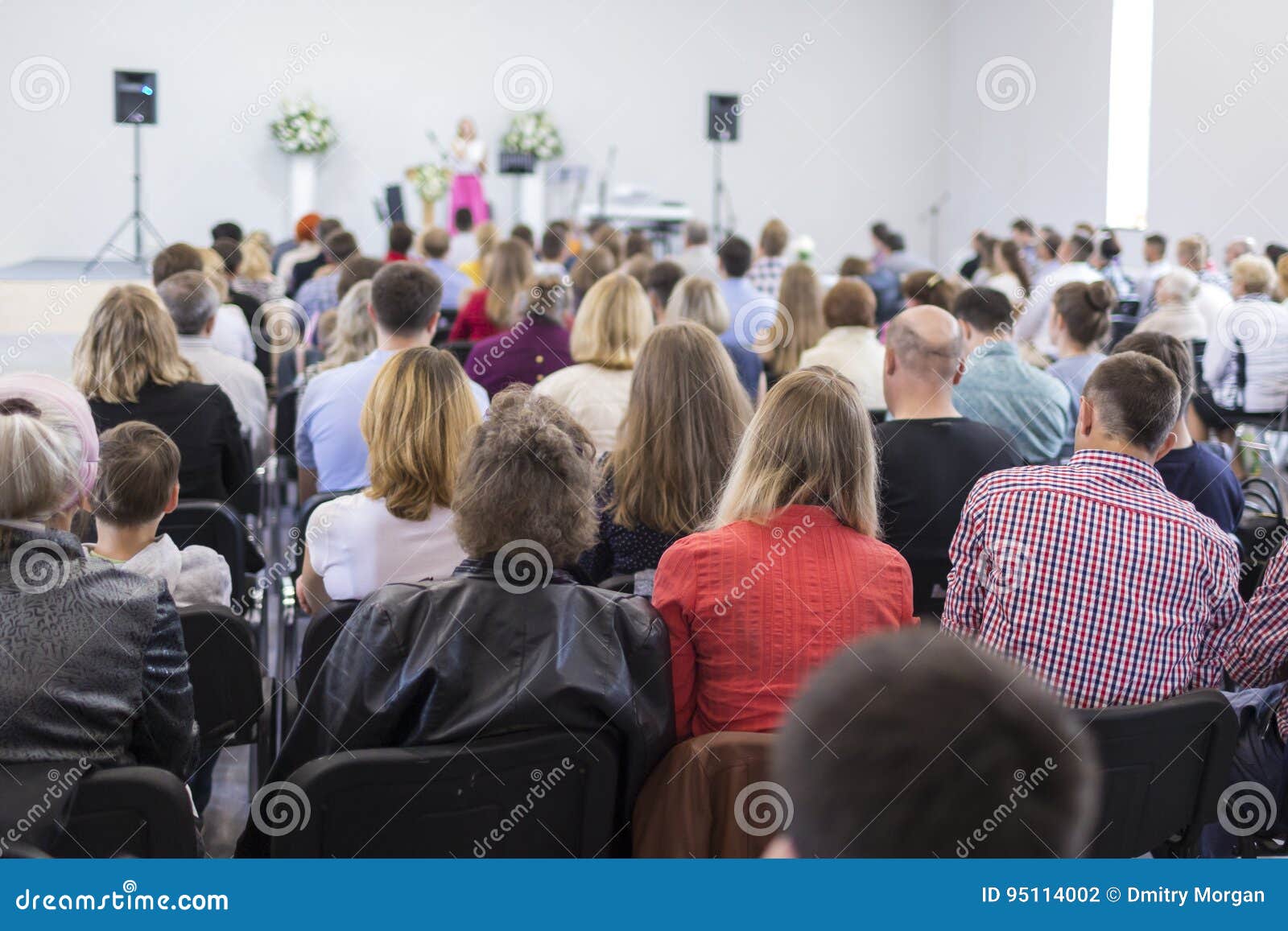 Male Host Speaking on Stage in Front of Group of Professionals ...