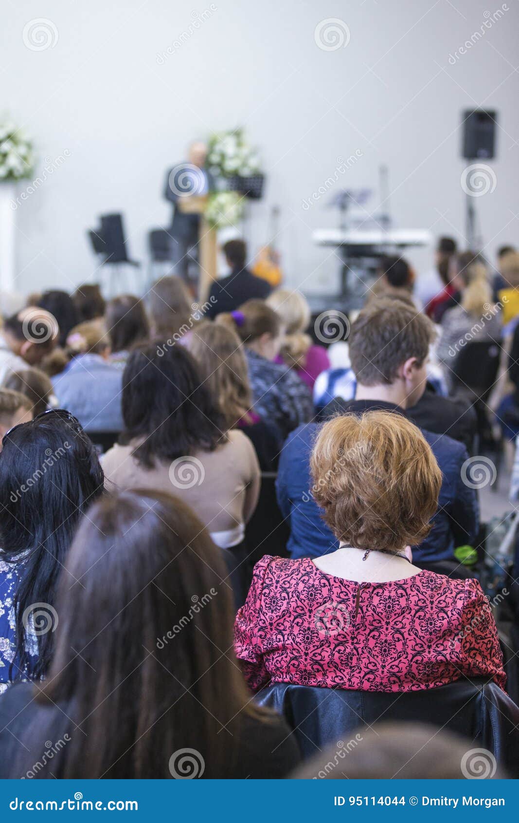 Male Host Speaking on Stage in Front of Group of Professionals ...
