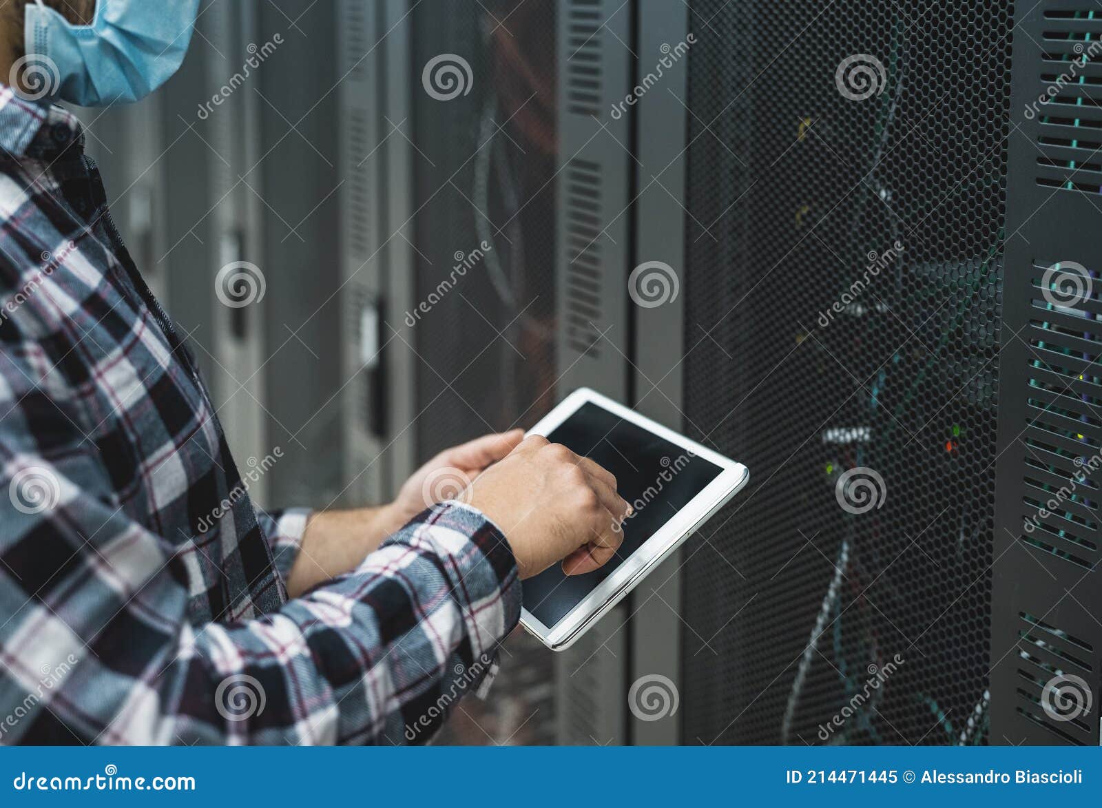 Male Informatic Engineer Working Inside Server Room Database while ...
