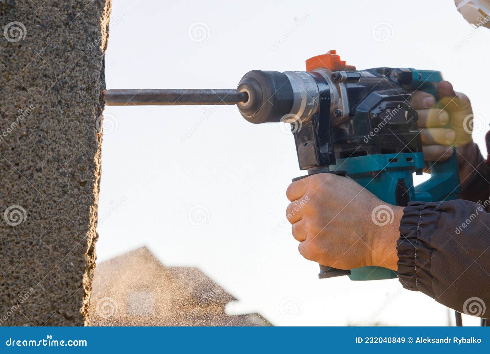 A Male Installer Works with a Hammer Drill. Construction Works. Stock ...