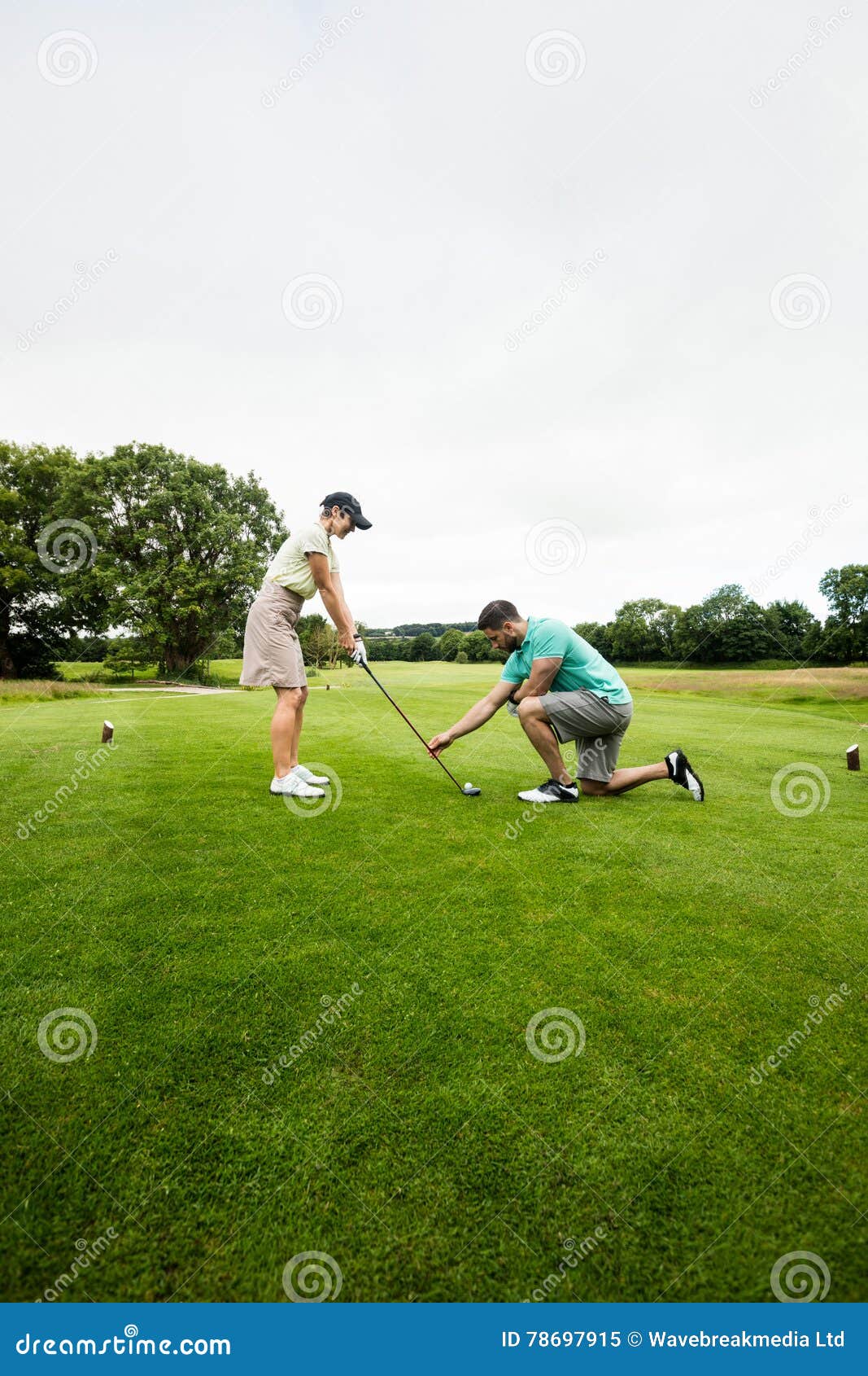 Male Instructor Assisting Woman in Learning Golf Stock Image - Image of ...